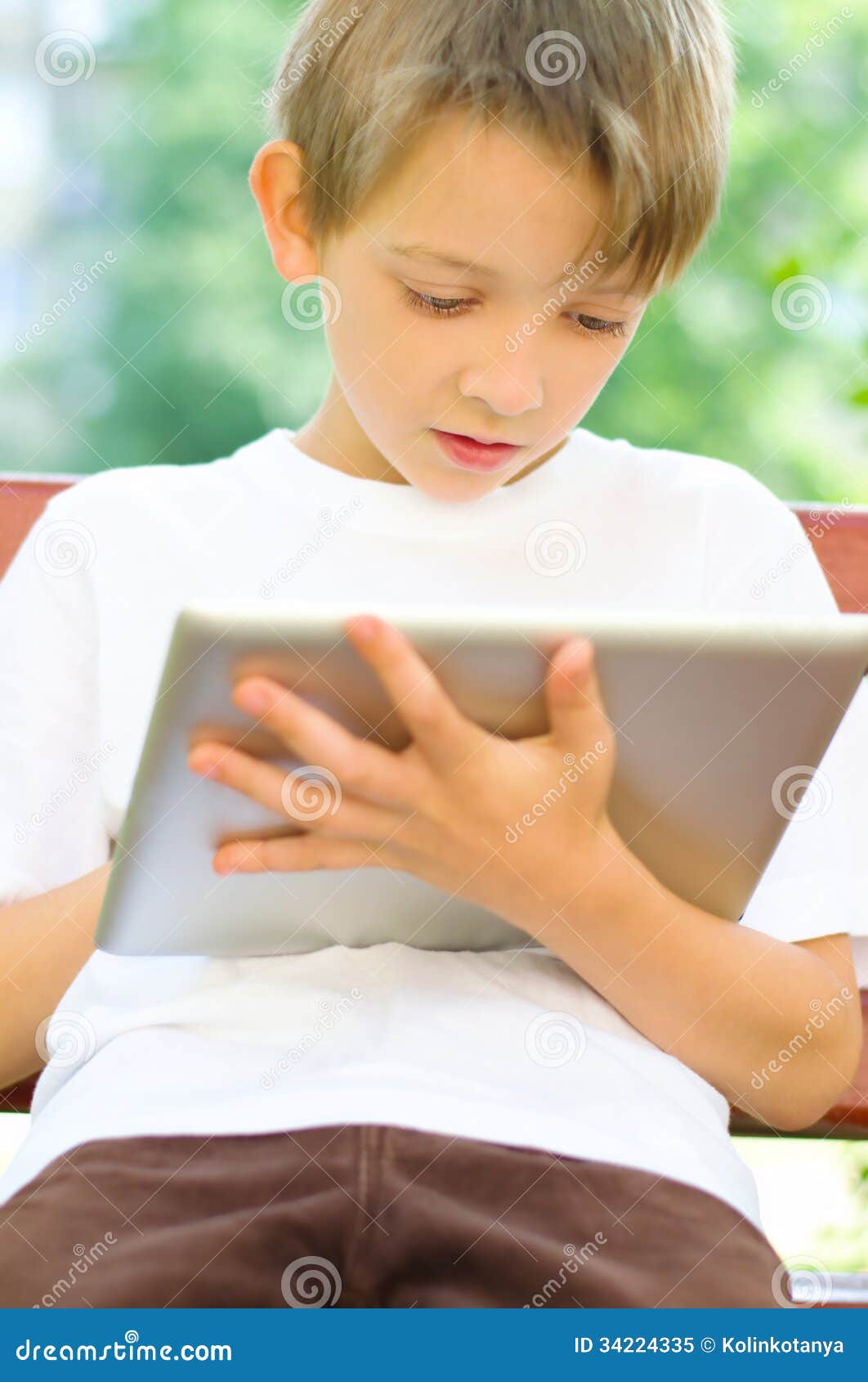 Little boy with tablet stock image. Image of reading - 34224335