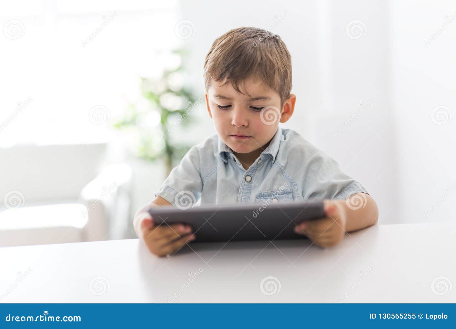 Little Boy with Tablet on the Kitchen Stock Image - Image of serious ...