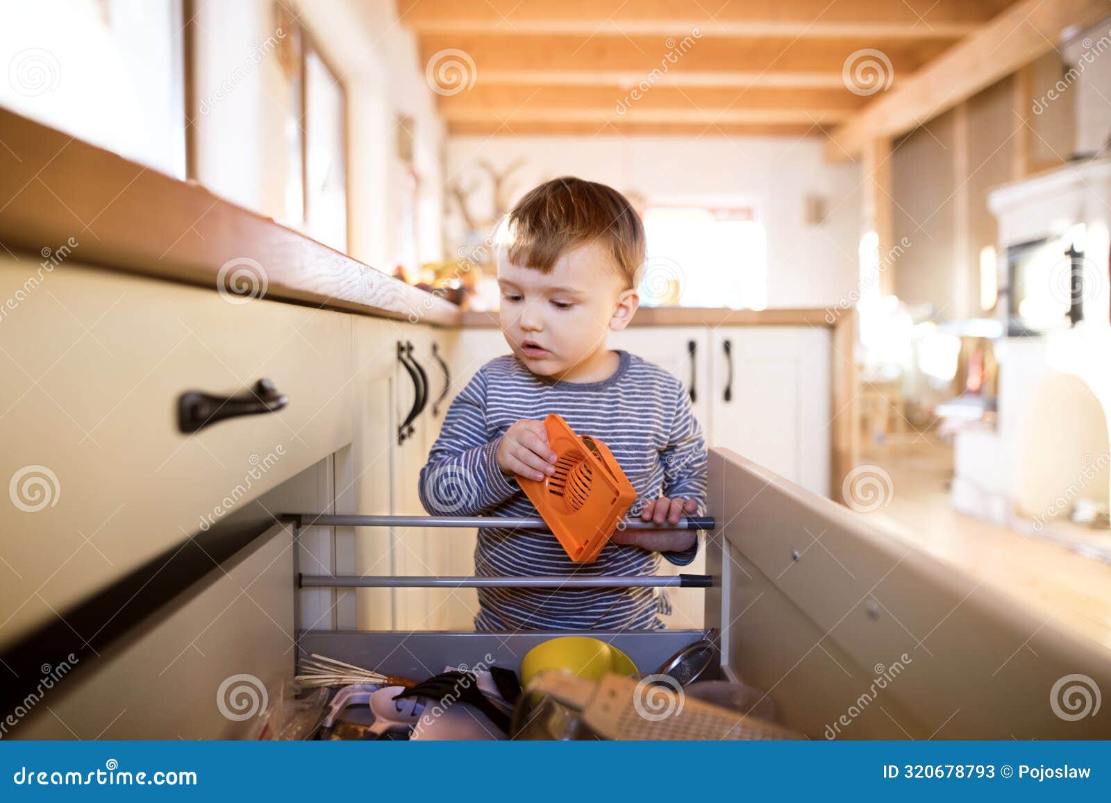 Little Boy is Taking Kitchen Utensils Out of the Drawers, Making a Mess ...