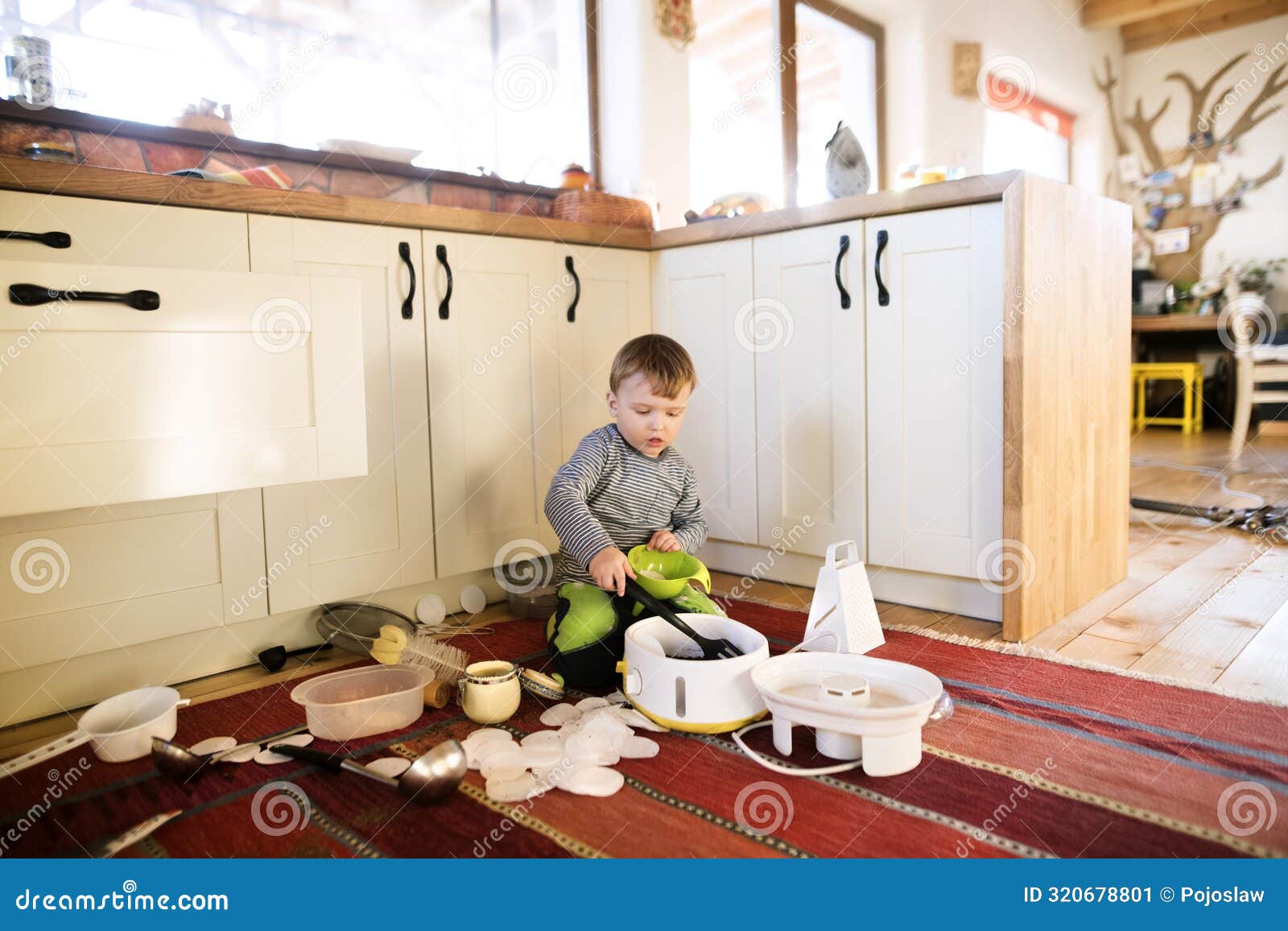 Little Boy is Taking Kitchen Utensils Out of the Drawers, Making a Mess ...