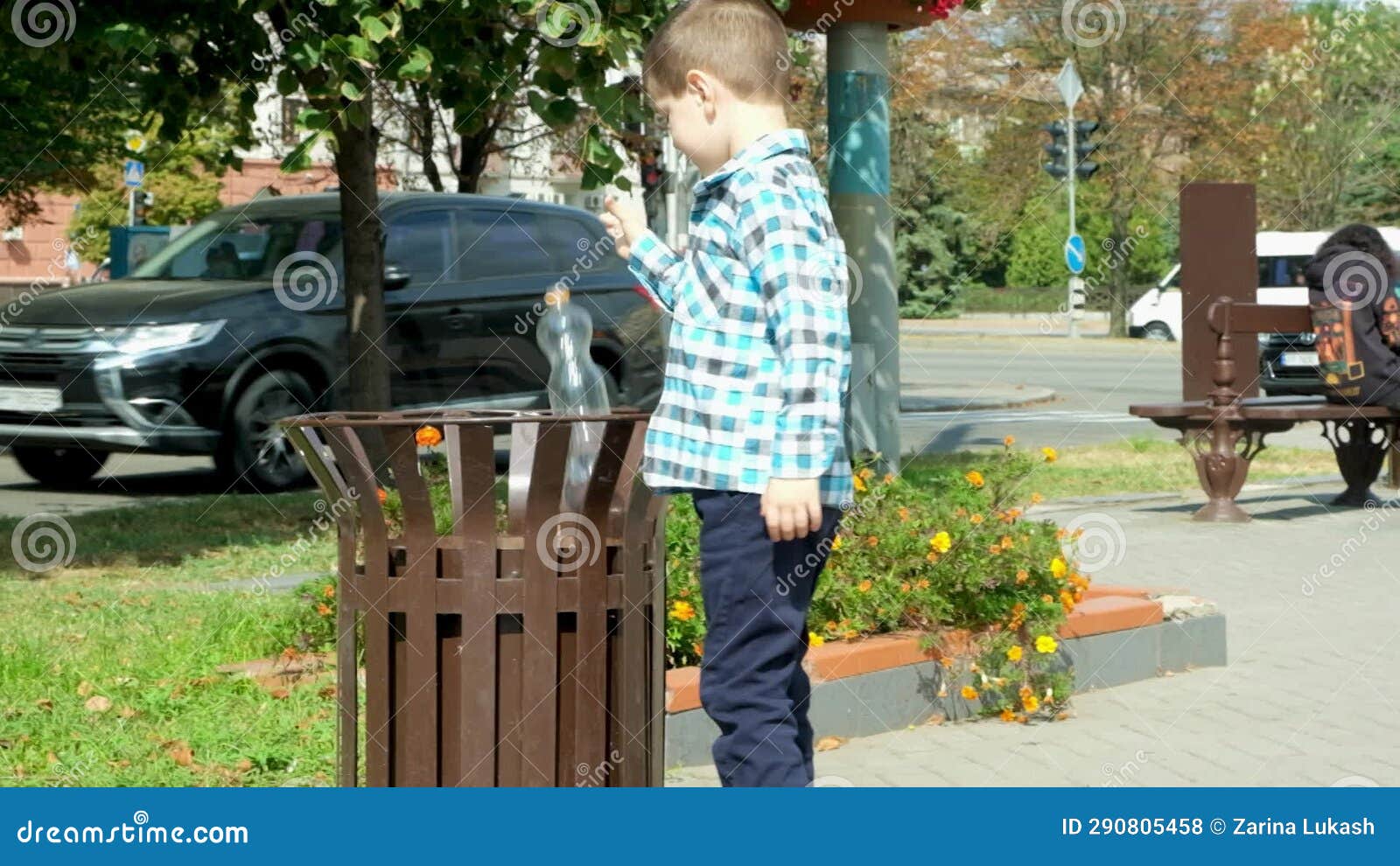 A Little Boy Throws a Plastic Bottle in the Trash. the Concept of Waste ...