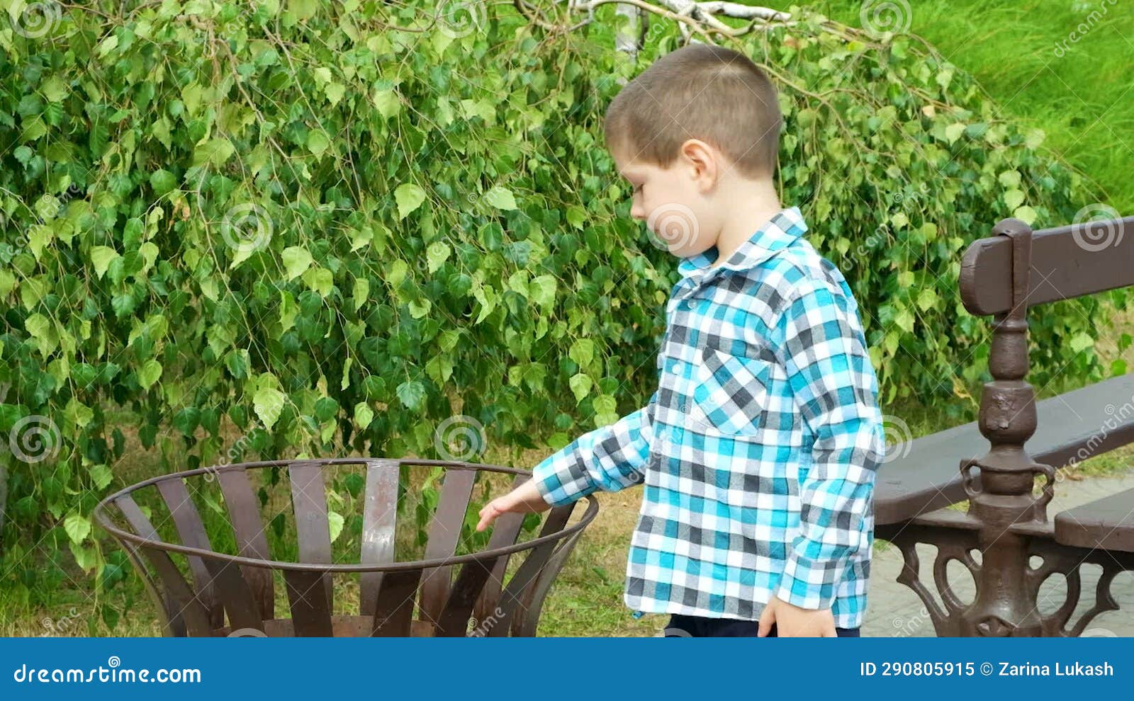 A Little Boy Throws a Plastic Bottle in the Trash. the Concept of Waste ...