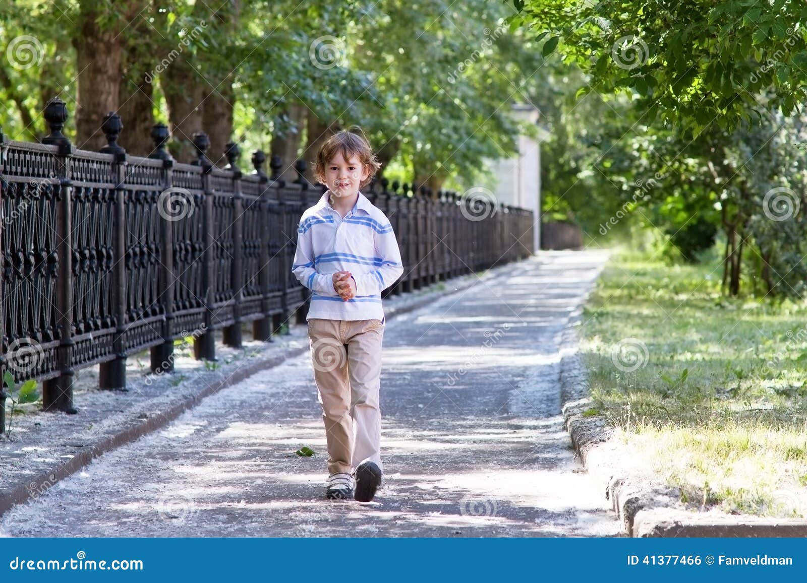 Little Boy Walking on a Sunny Street Stock Photo - Image of portrait ...