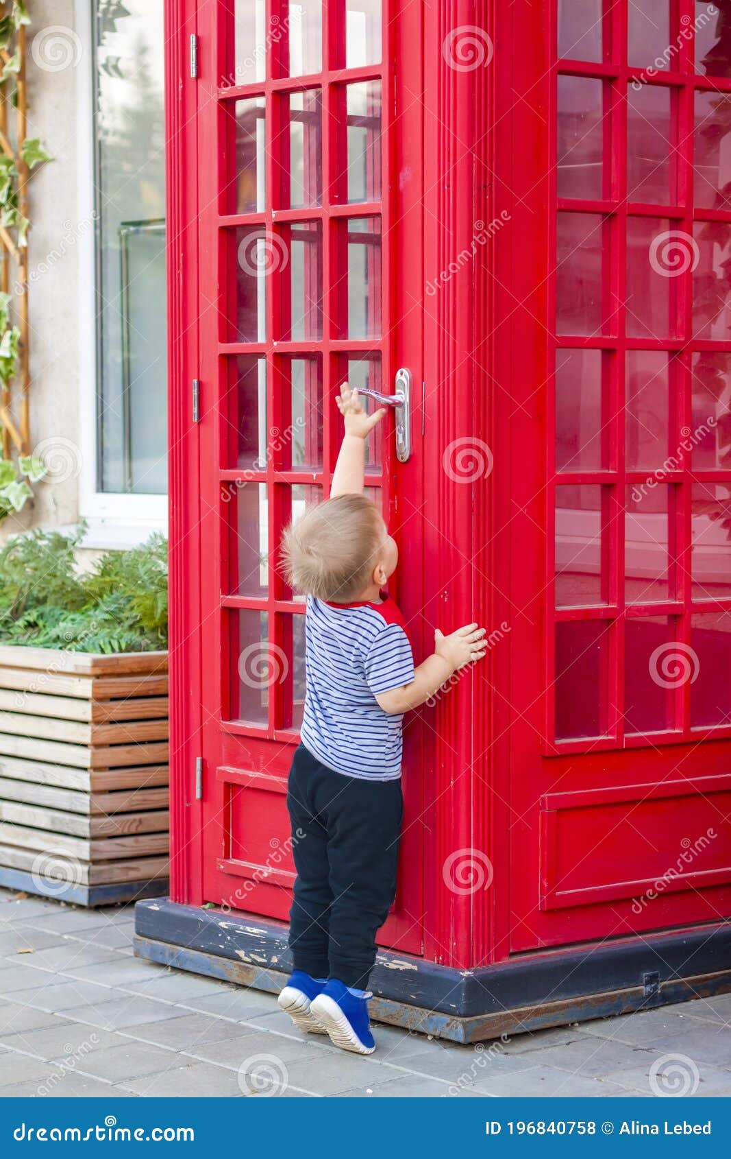 A Little Boy Wants To Enter a Red Phone Booth. Stock Photo - Image of ... A Little Boy Wants To Enter a Red Phone Booth. Stock Photo - Image of ...