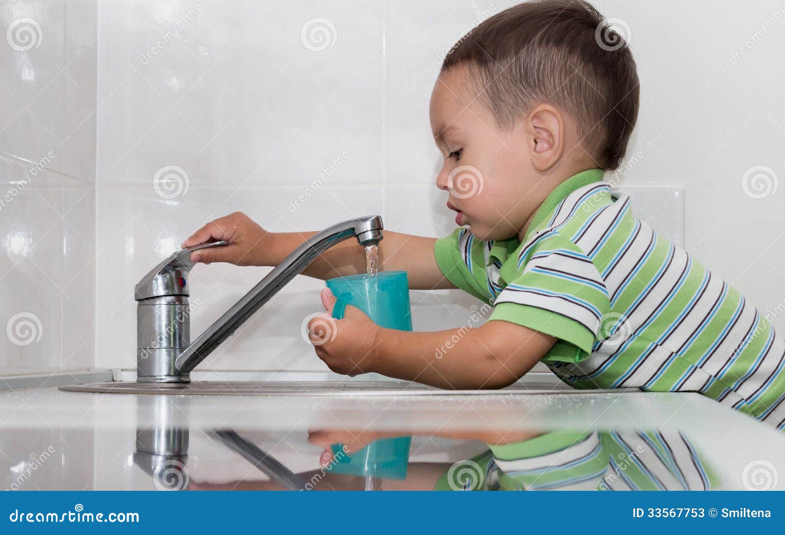 Little boy washing dishes stock image. Image of sink - 33567753