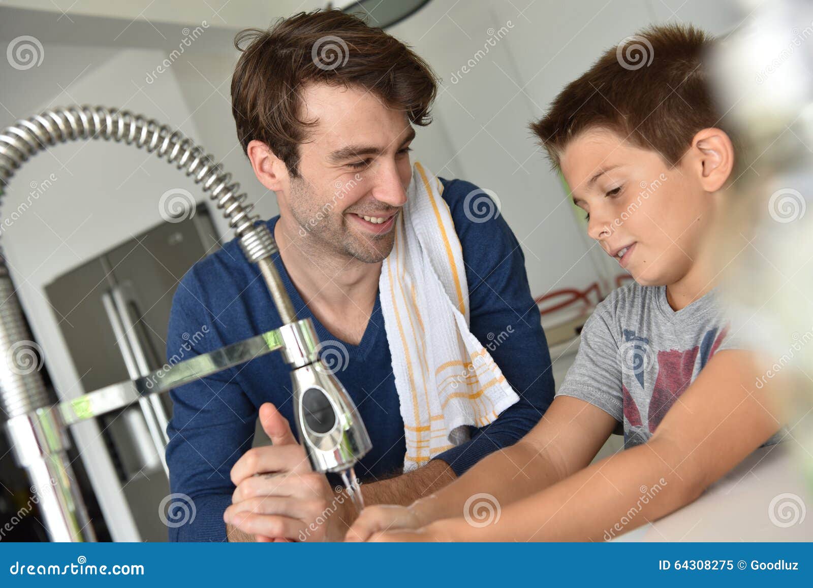 Little Boy Washing Hands in the Kitchen with His Father beside Stock ...