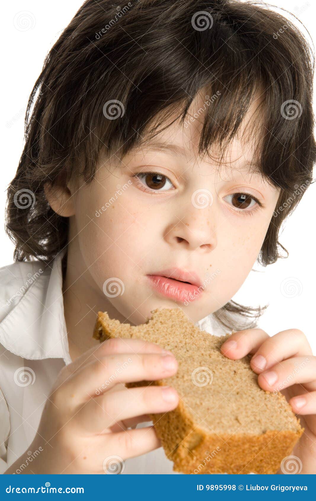 The Little Boy Which Eating a Bread on Desk Stock Photo - Image of ...
