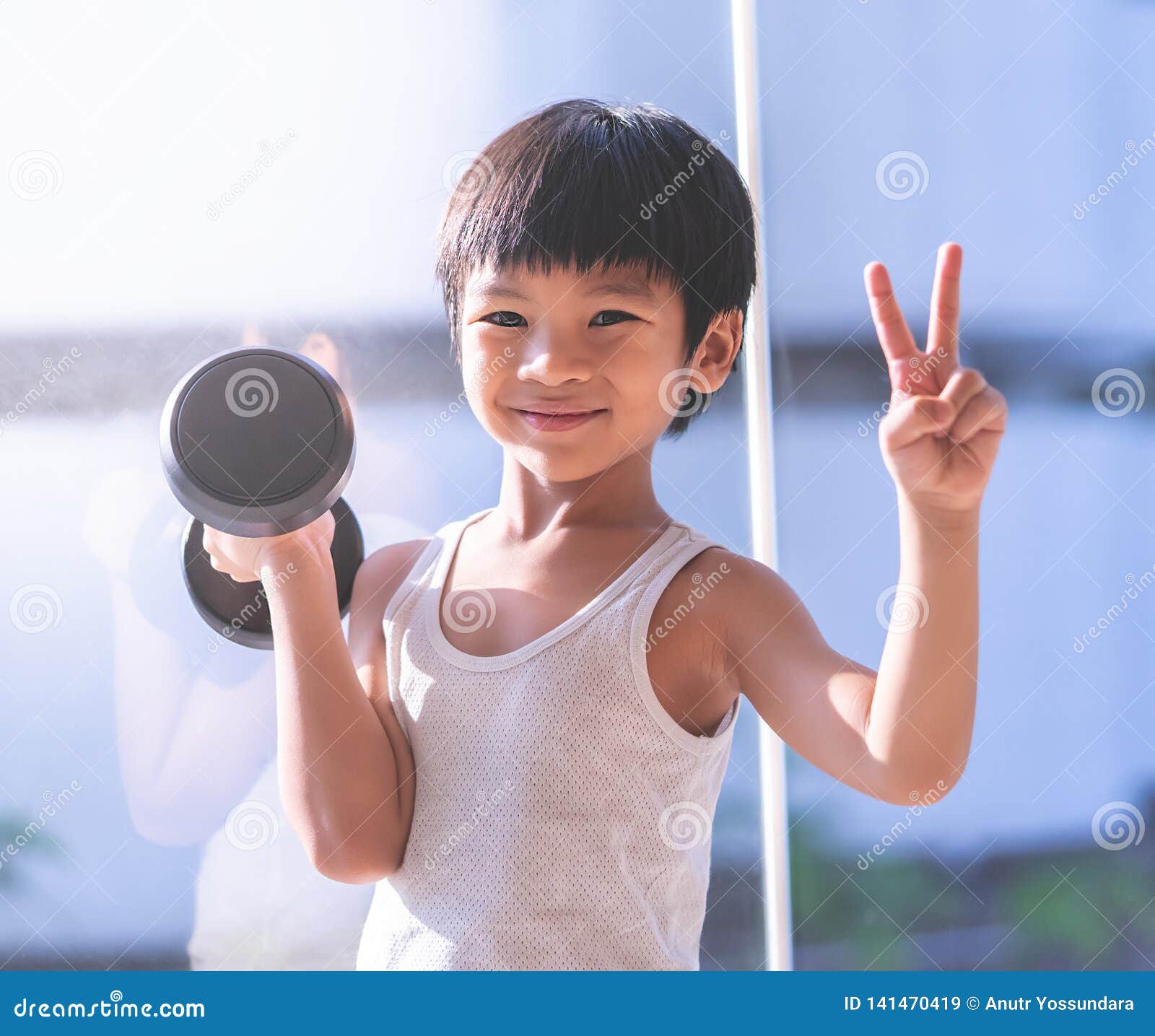 Boy is Working Out with Dumbbell by the Windows City Stock Image ...