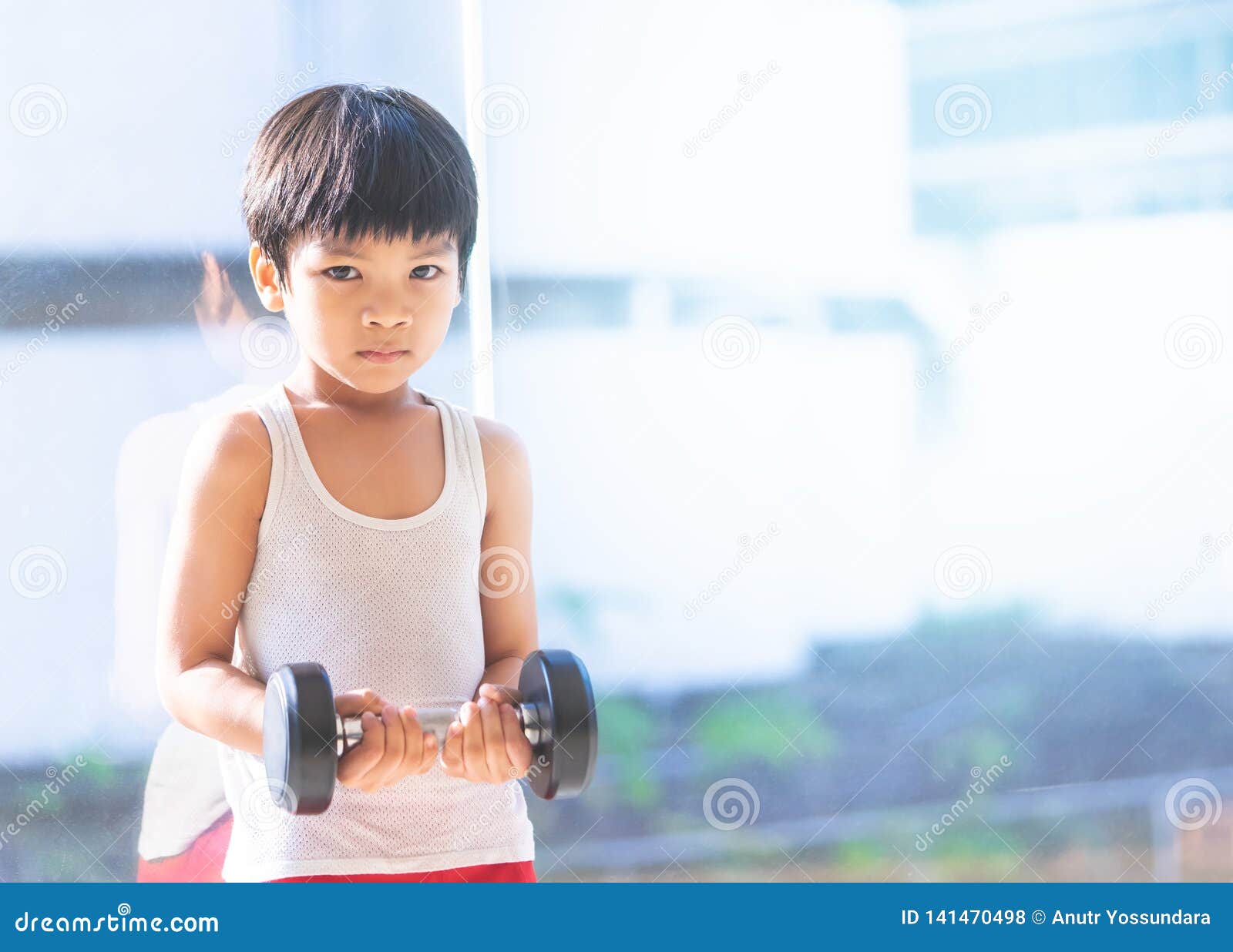Little Boy Working Out with Dumbbell by the Windows City Stock Photo ...