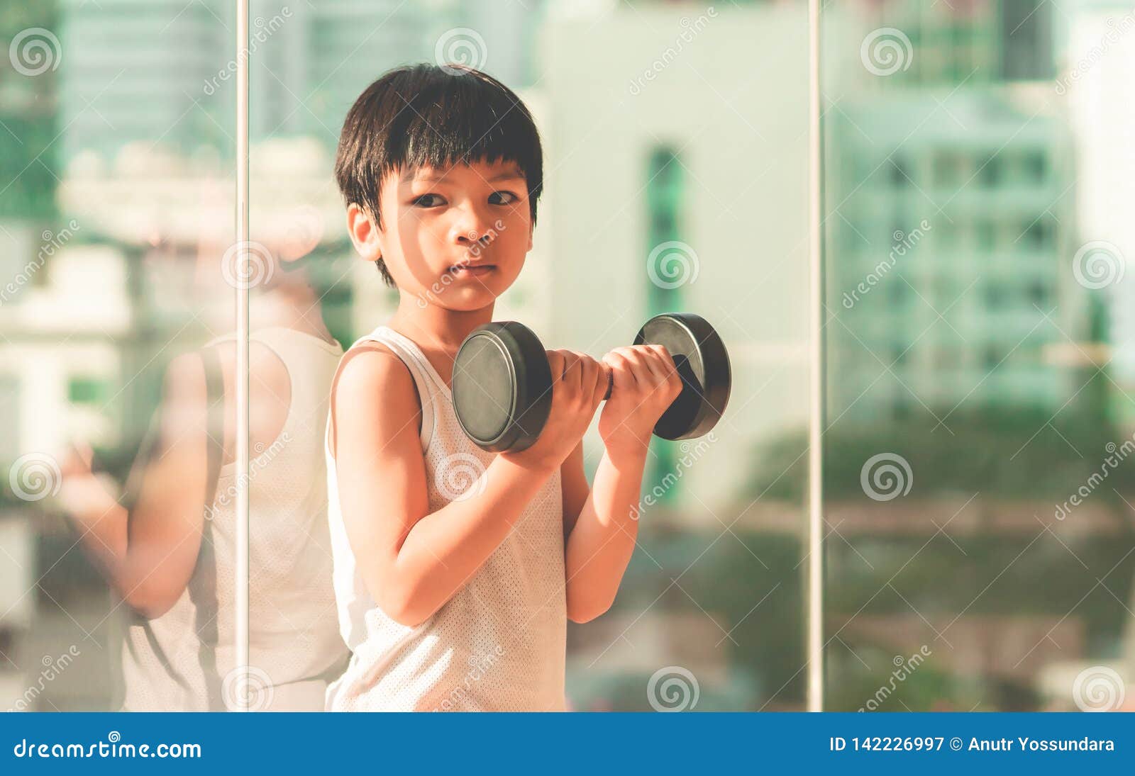 Little Boy Working Out with Dumbbell by the Windows City Stock Image ...