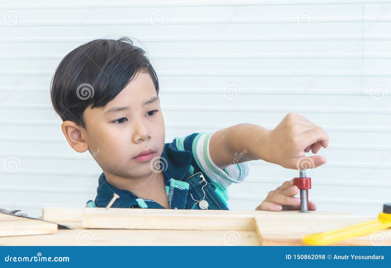 Boy is Working Out Tool on Woodwork in Workshop Stock Photo - Image of ...