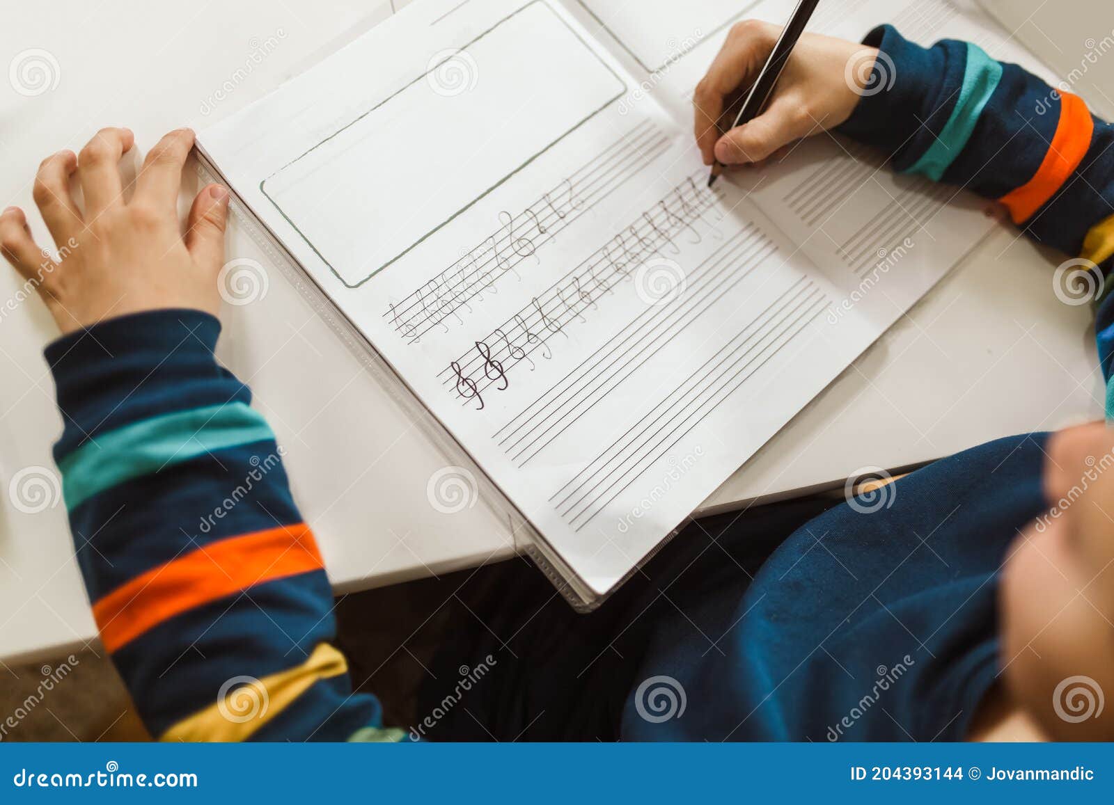 Boy Writes Musical Notes And Violin Key At Home Online Course On Laptop ...