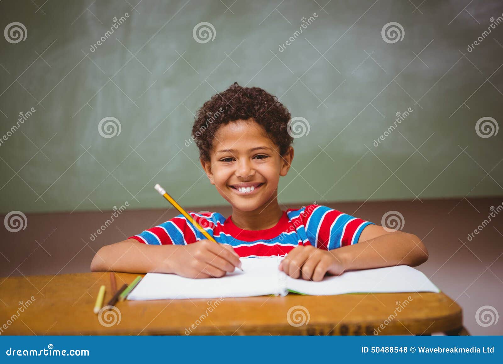 Little Boy Writing Book in Classroom Stock Photo - Image of book ...