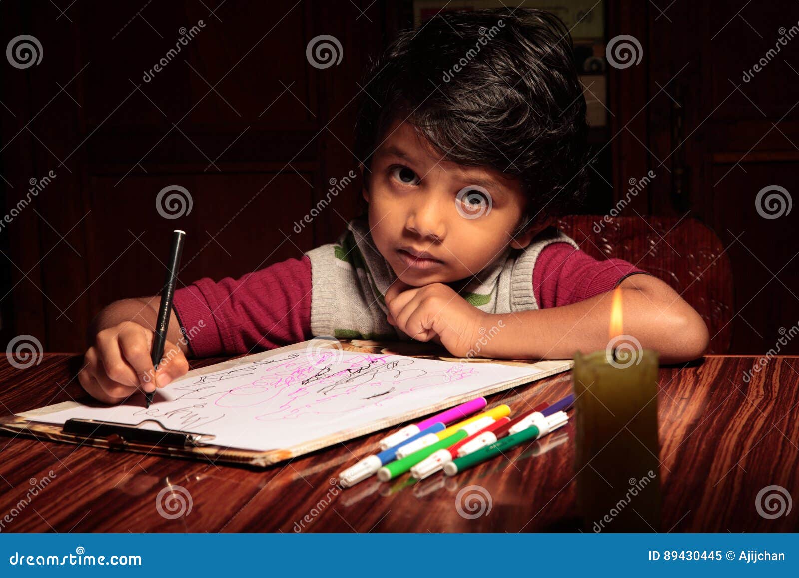 Little Boy Writing with a Burning Candle Stock Image - Image of ...
