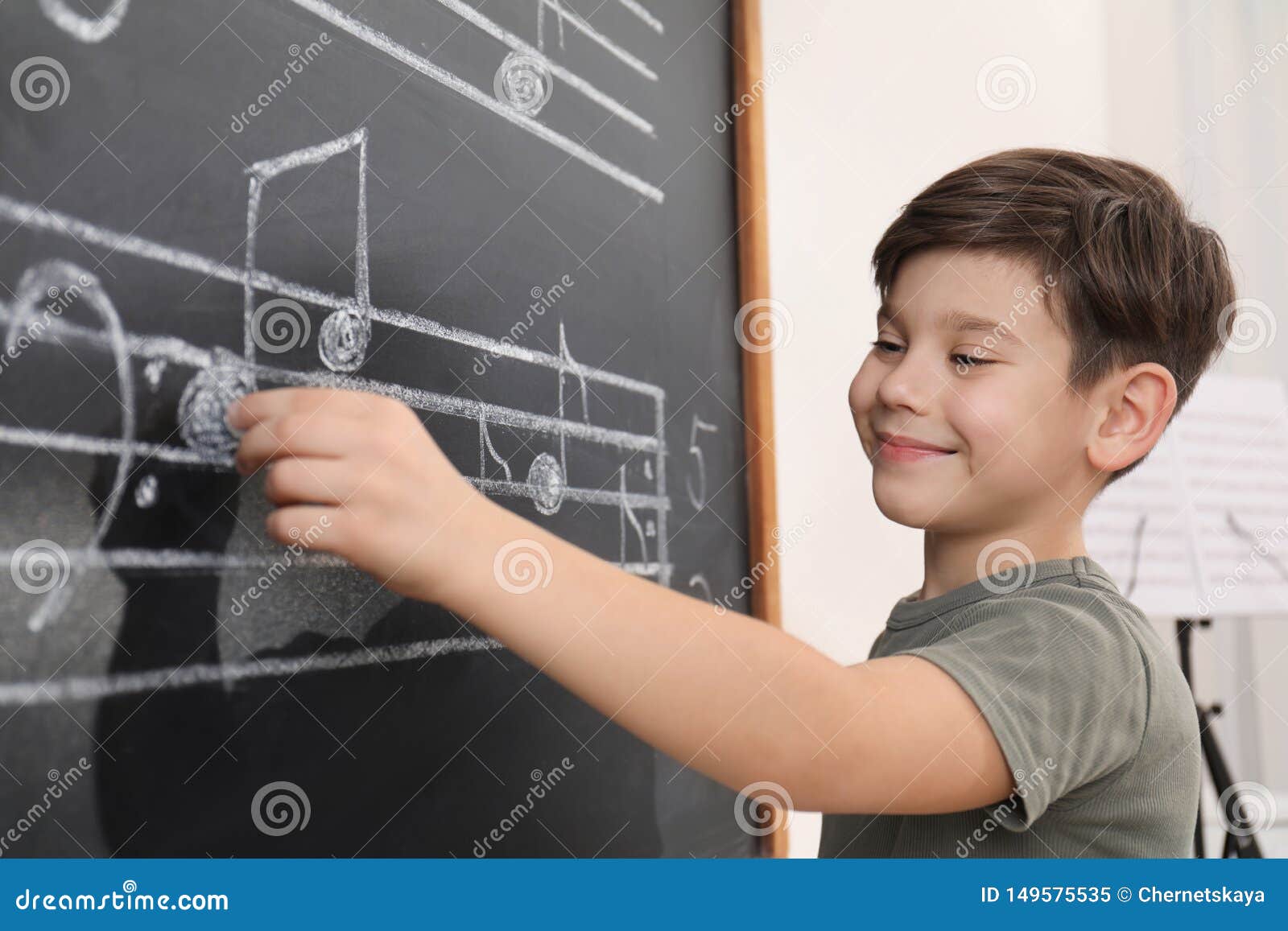 Little Boy Writing Music Notes on Blackboard Stock Image - Image of ...