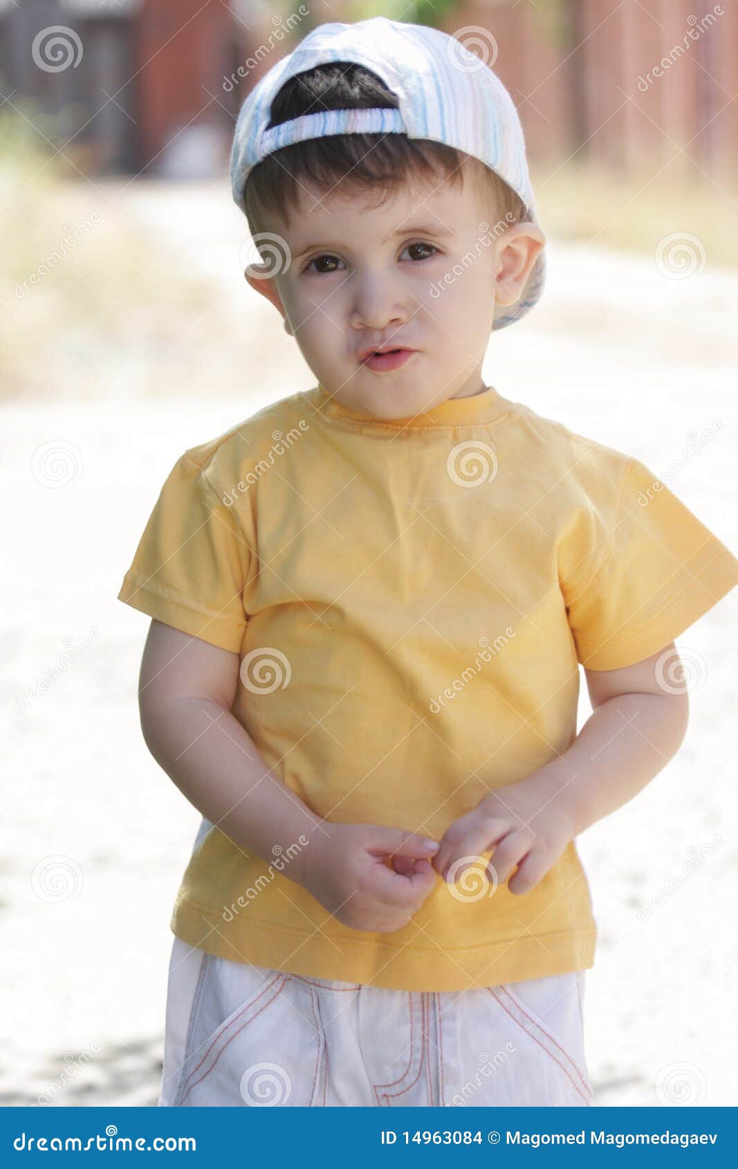 Little Boy in Yellow Shirt and Cap Stock Photo - Image of child, yellow ...
