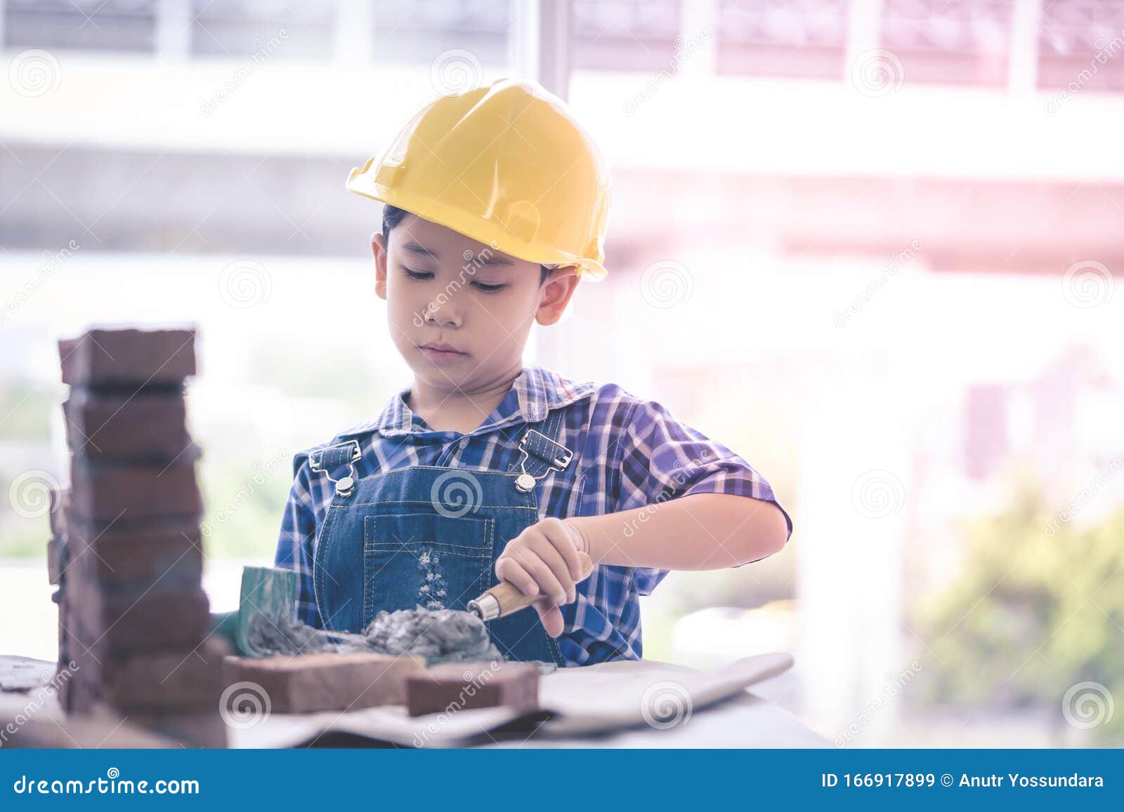Little Builder Boy Learning How To Build Brick Wall in Vintage Tone ...