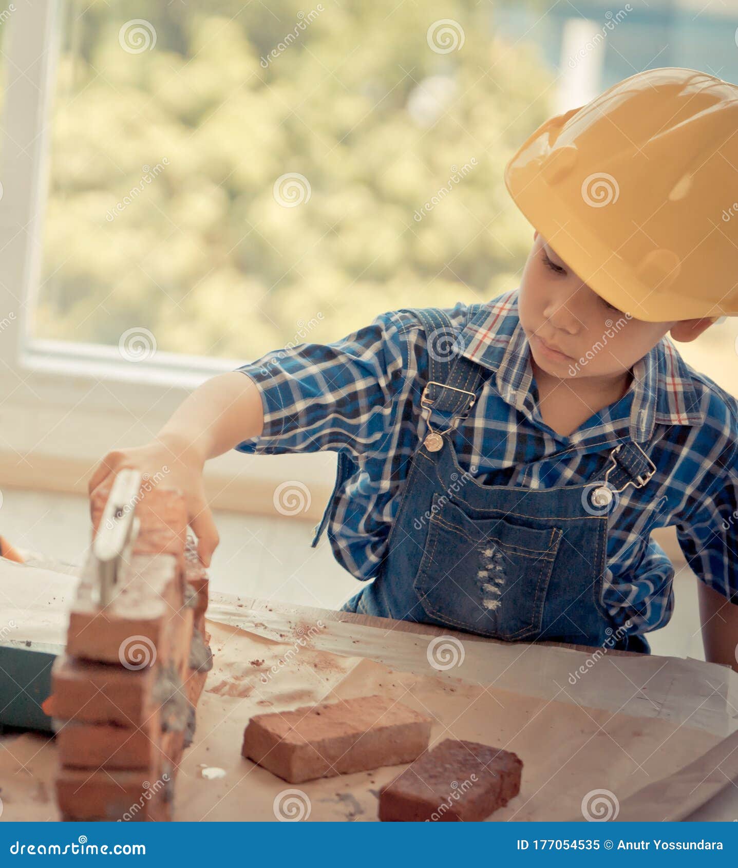 Little Builder Boy Learning How To Build Brick Wall in Vintage Tone ...