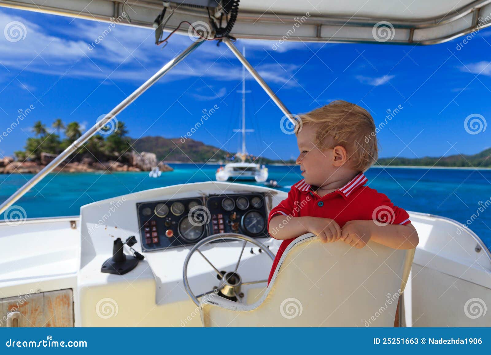 A Little Captain At The Helm On A Yacht. A Little Boy At The Helm Of ...