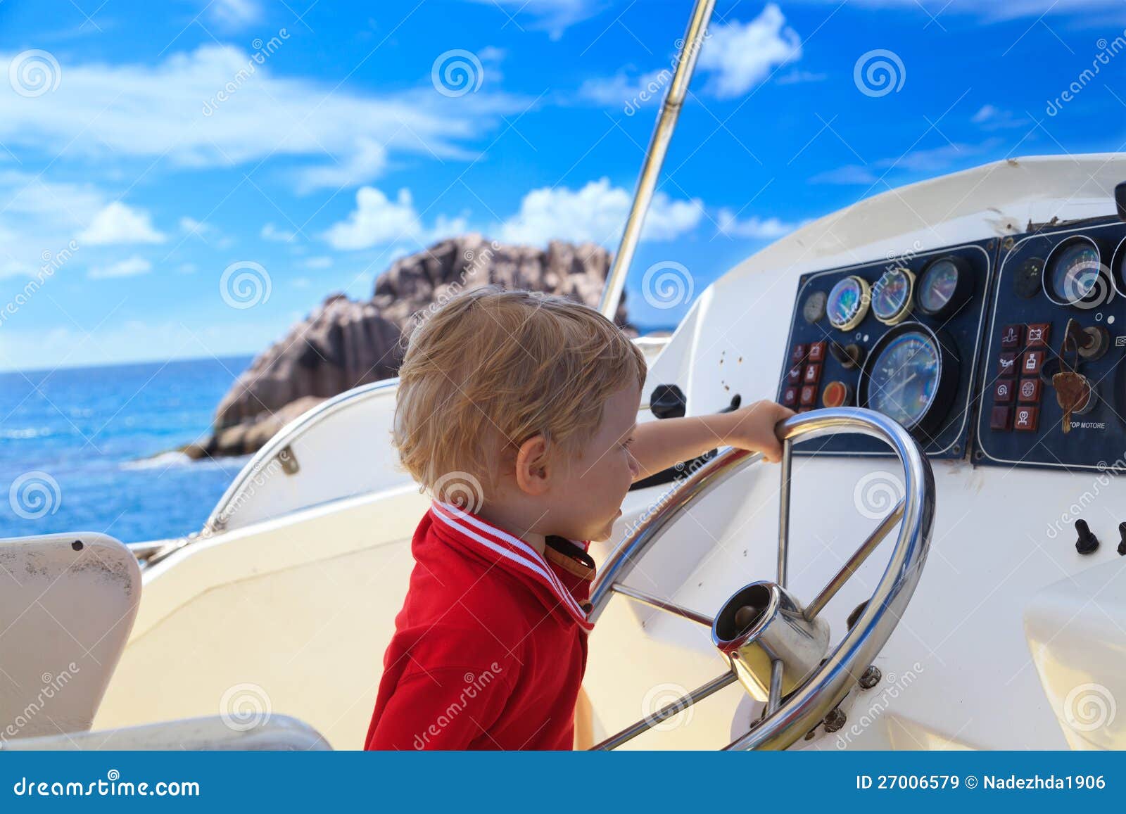 A Little Captain At The Helm On A Yacht. A Little Boy At The Helm Of ...