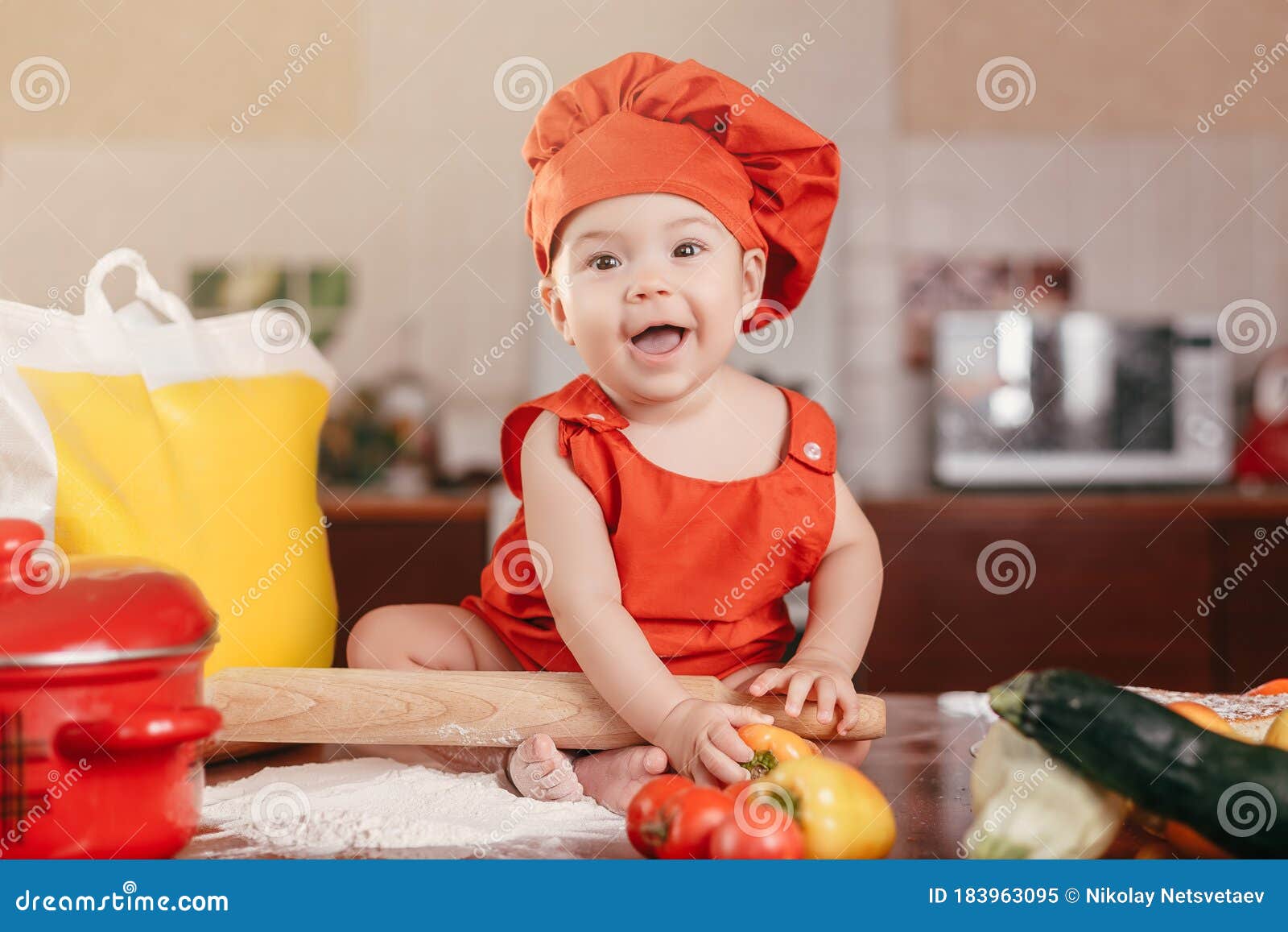 Little Chef is Sitting on the Kitchen Table with Groceries Stock Image ...