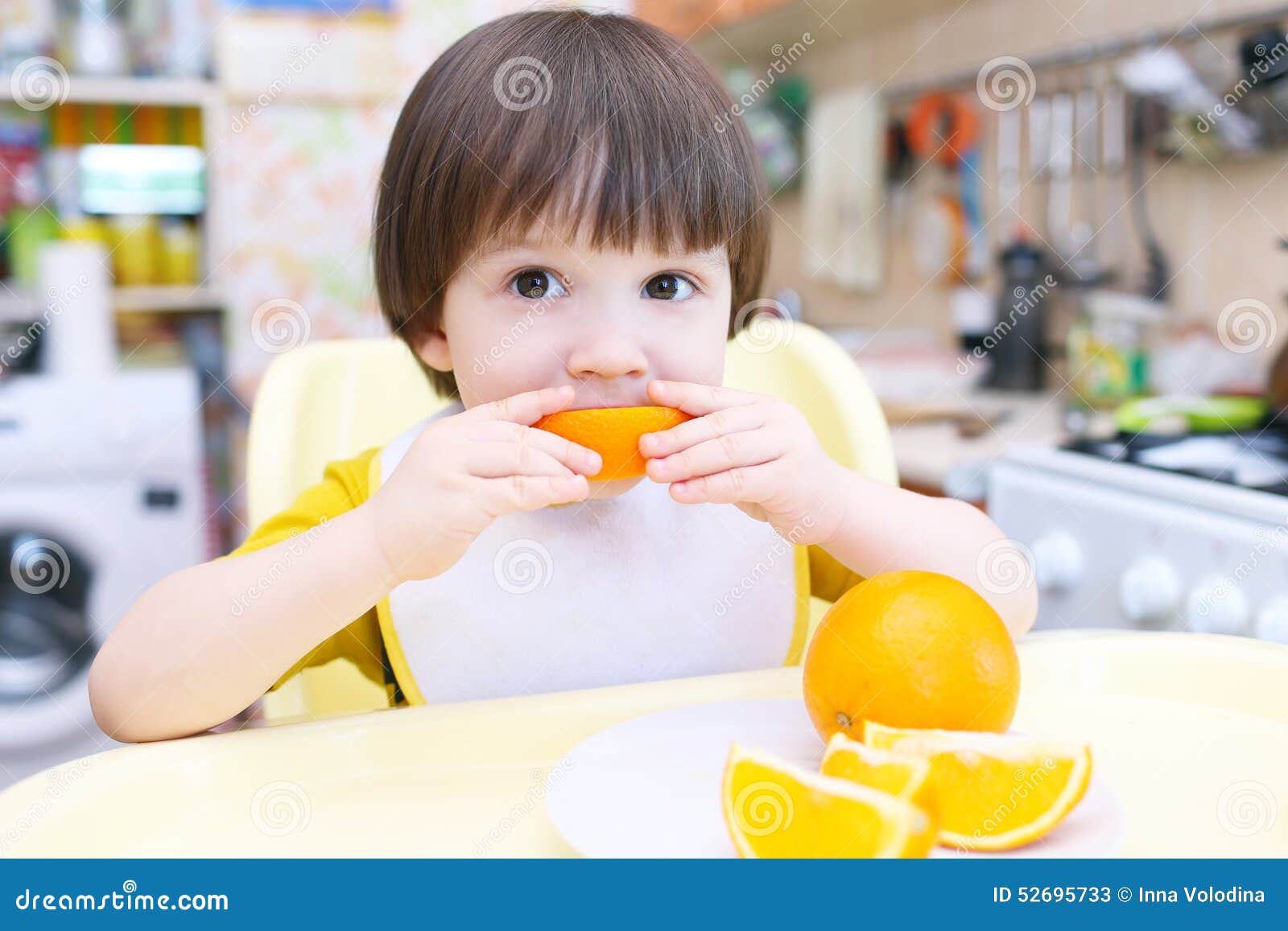 Little child eats orange stock image. Image of fruit - 52695733