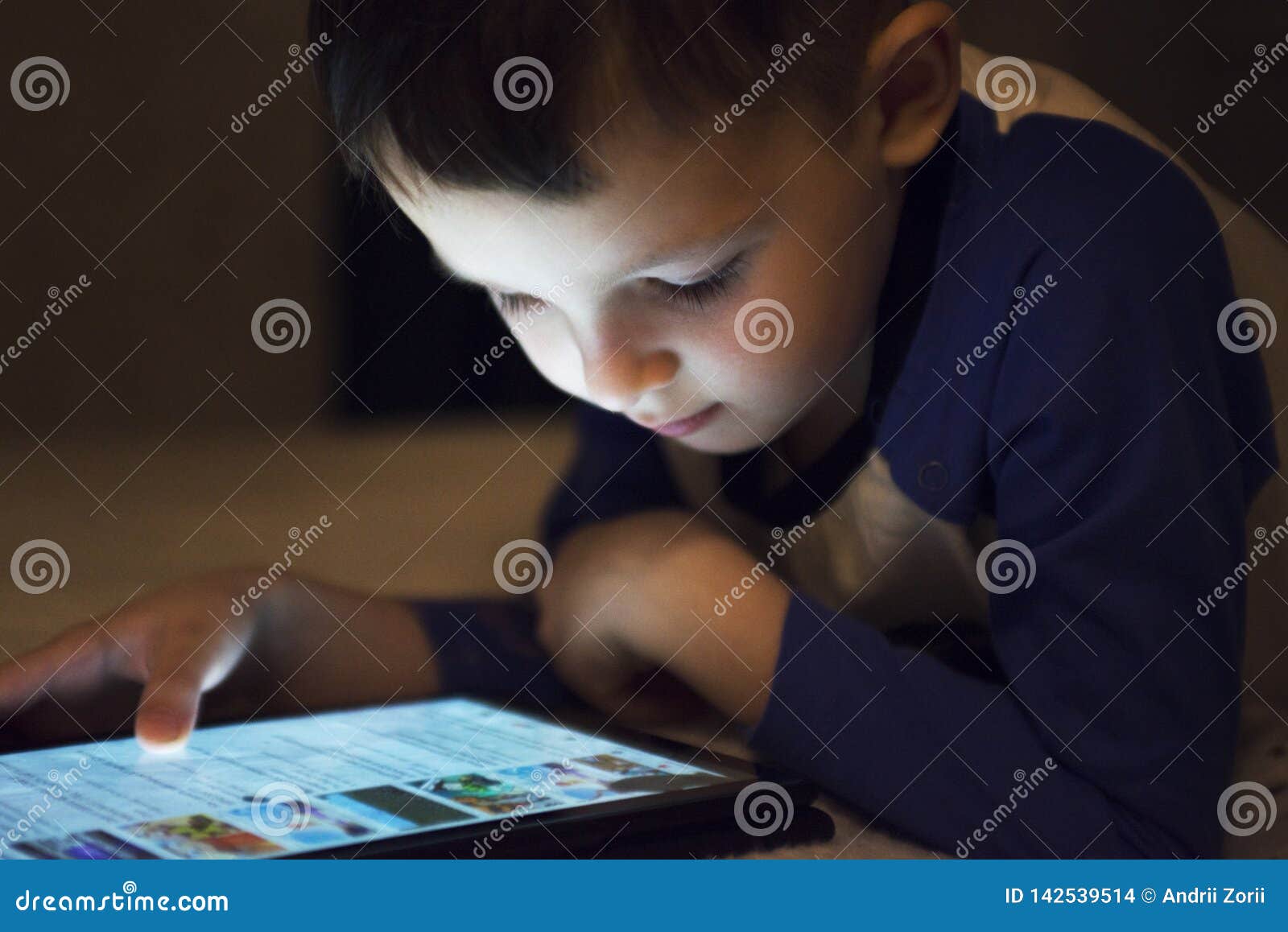 Little Child Kid Using Tablet Technology in Bed by Night at Home Stock ...
