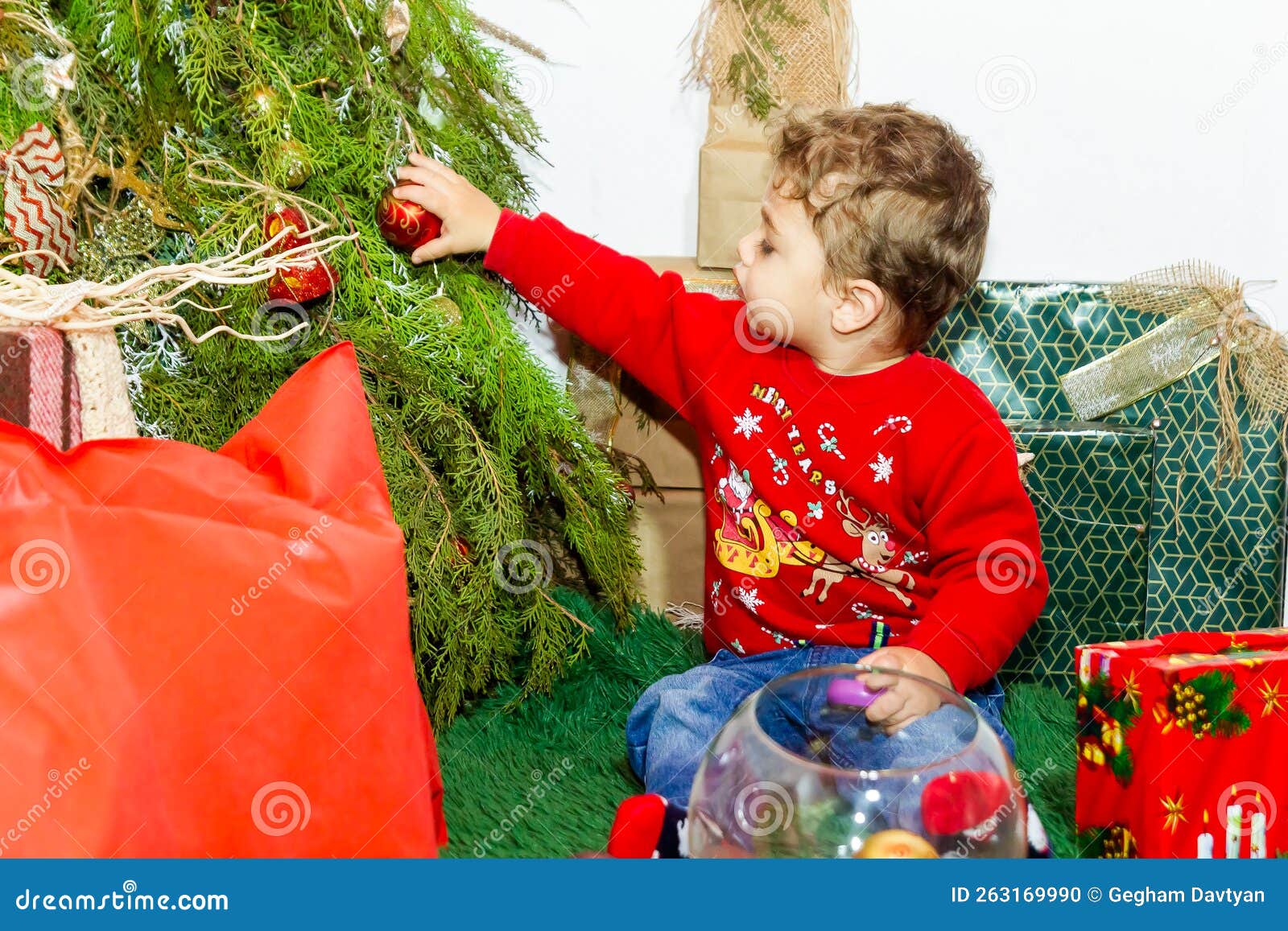 Little Child Playing with Christmas Decorations in Studio, Little Child ...