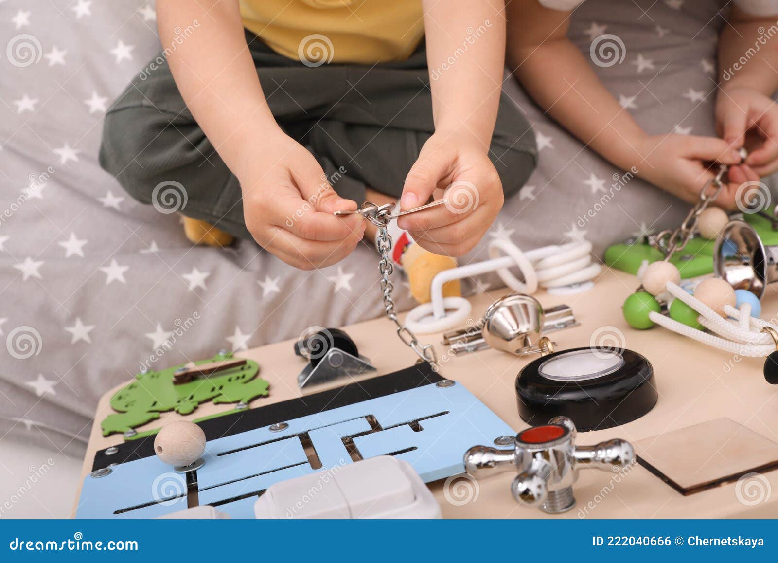 Little Children Playing with Busy Board on Bed Stock Photo - Image of ...