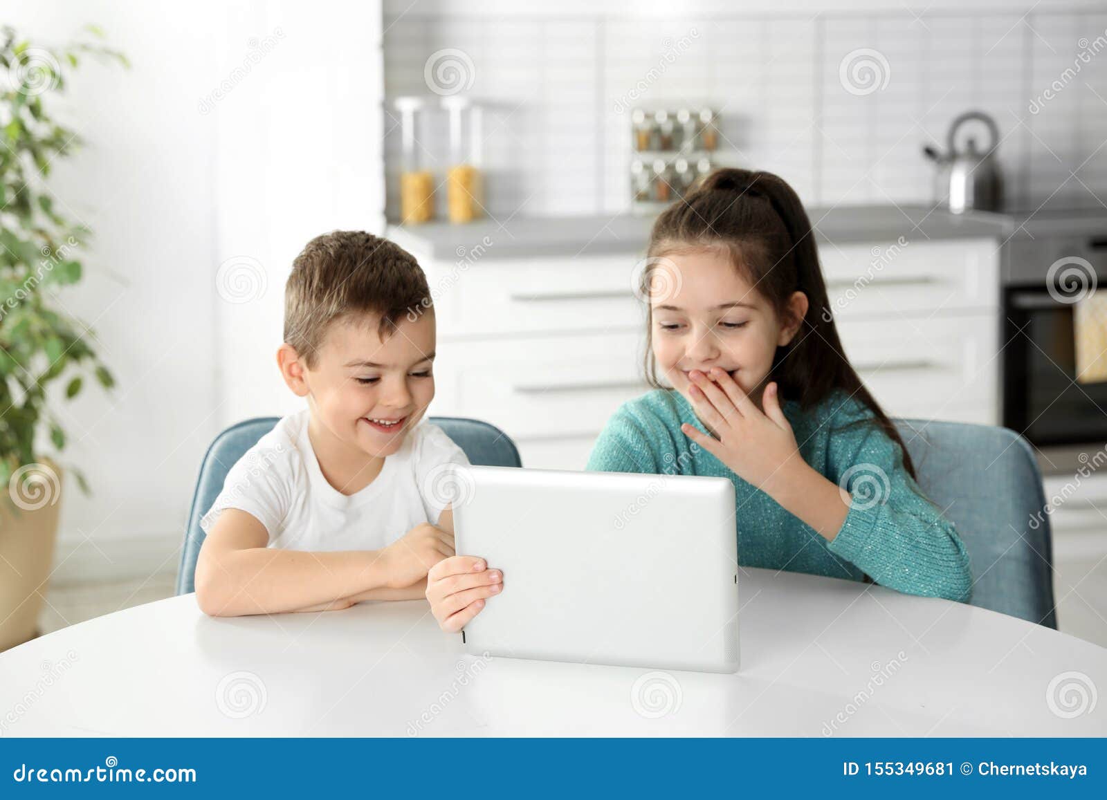 Little Children Using Video Chat on Tablet at Table Stock Image - Image ...