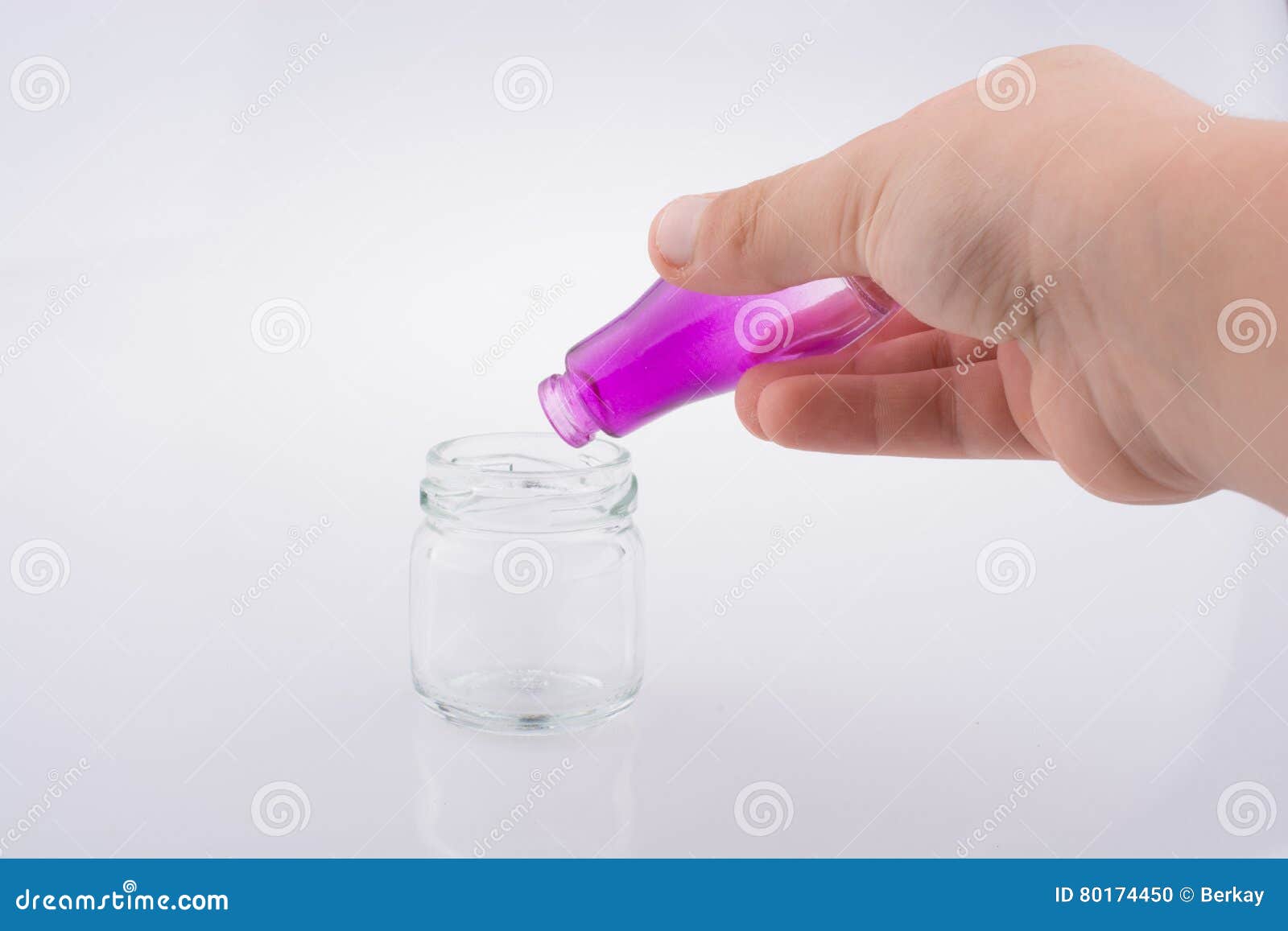 Little Colorful Bottle Over a Jar Stock Photo - Image of hand, pour ...