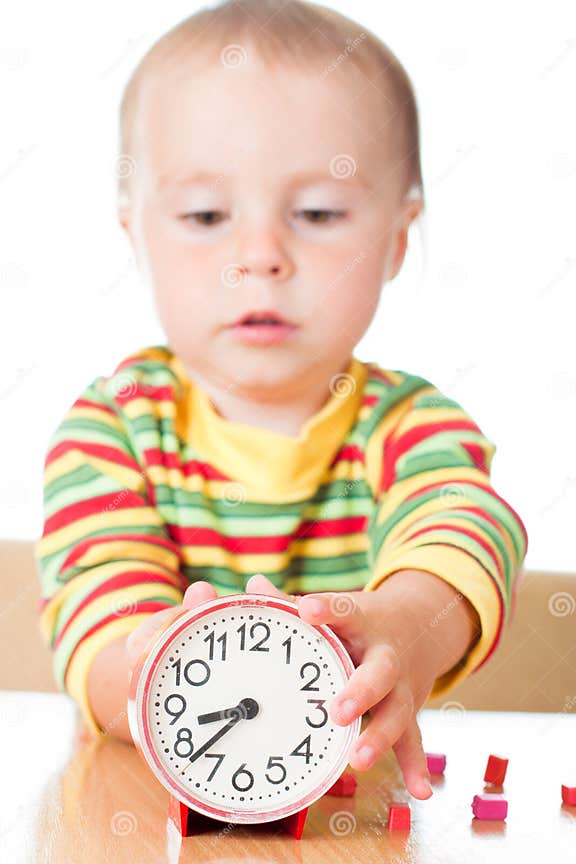 Little Cute Baby with Clock Stock Image - Image of hand, looking: 28595167