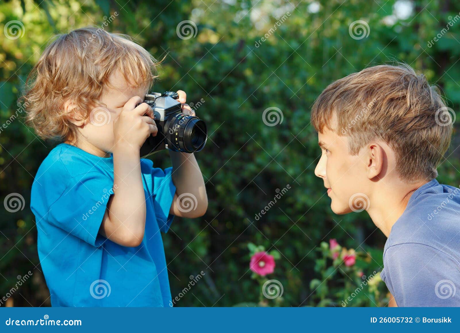 Little Cute Blond Boy with a Camera Shoots Brother Stock Photo - Image ...