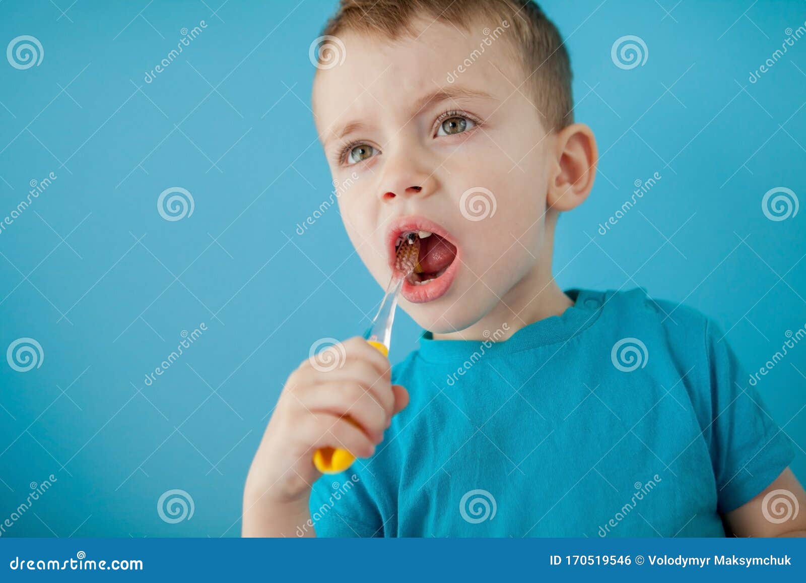 Little Cute Boy Brushing His Teeth on Blue Background Stock Photo ...
