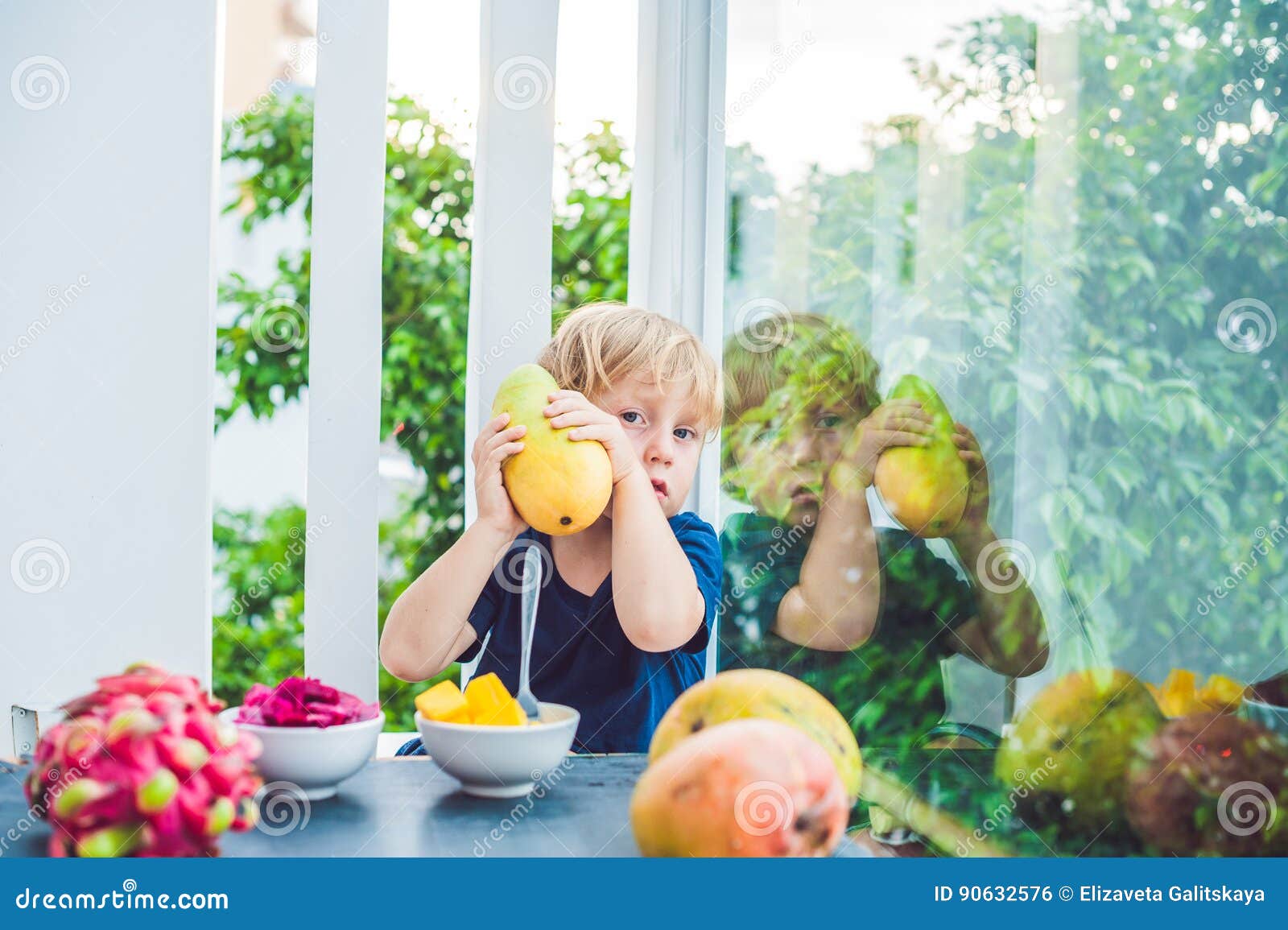 Little Cute Boy Eating Mango on the Terrace Stock Photo - Image of ...