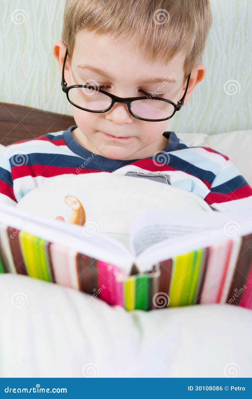 Little Cute Boy Reading Book in Bed Stock Photo - Image of face, cute ...