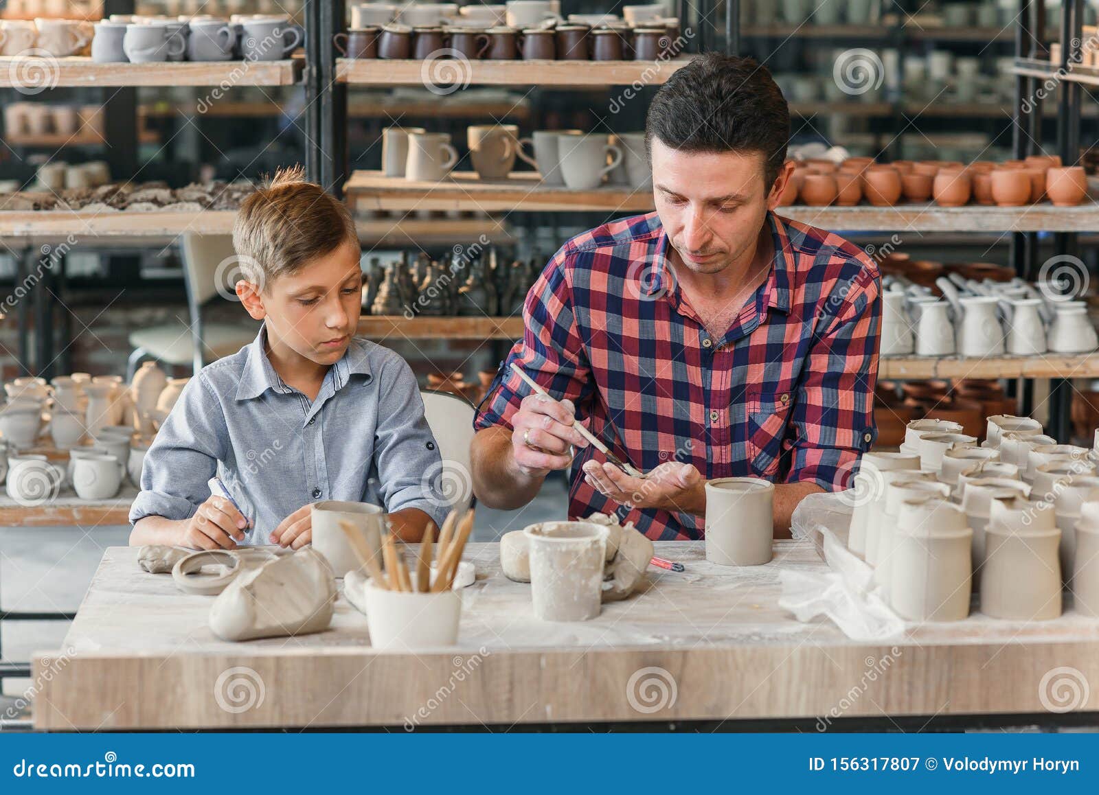 Little Cute Boy with His Father Making Ceramic Pots in the Pottery ...