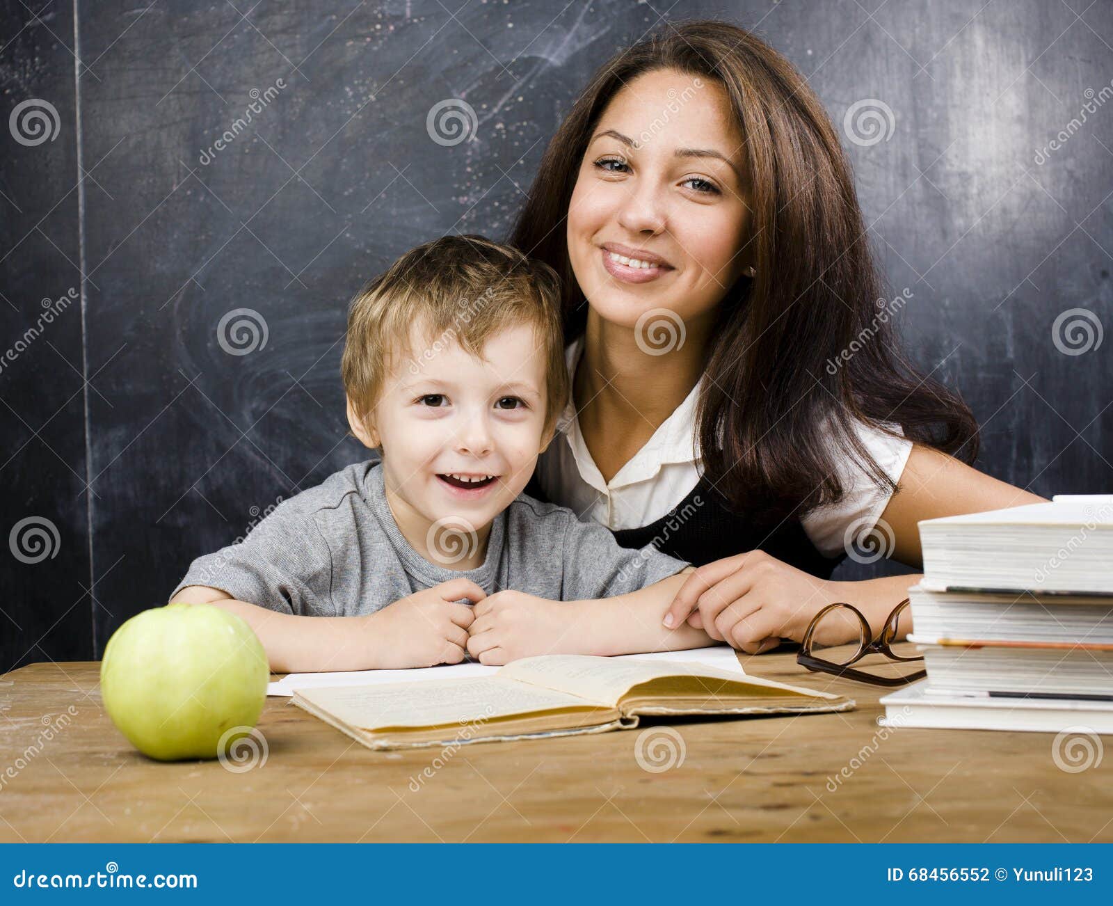 Little Cute Boy with Young Teacher in Classroom Studying at Blackboard ...