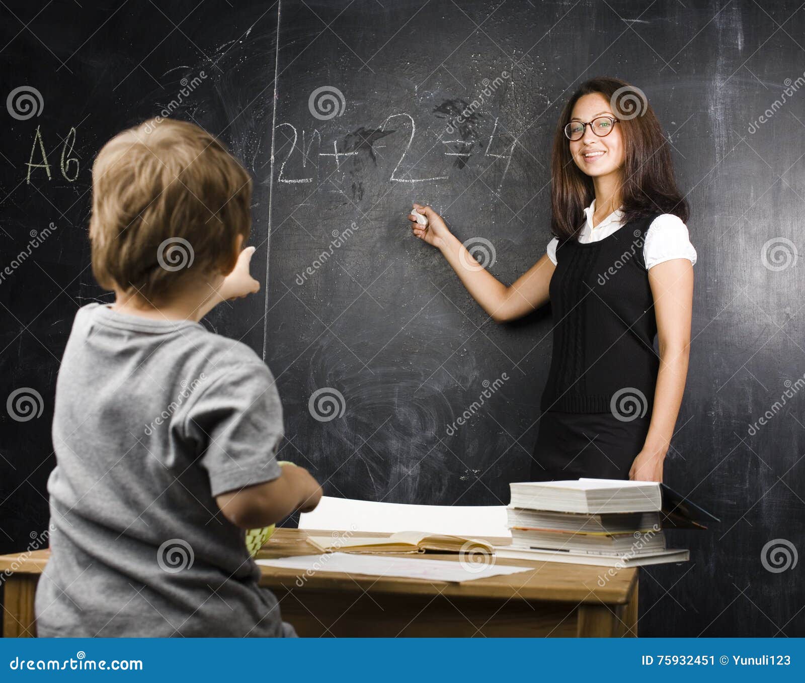 Little Cute Boy with Young Teacher in Classroom Studying at Blackboard ...