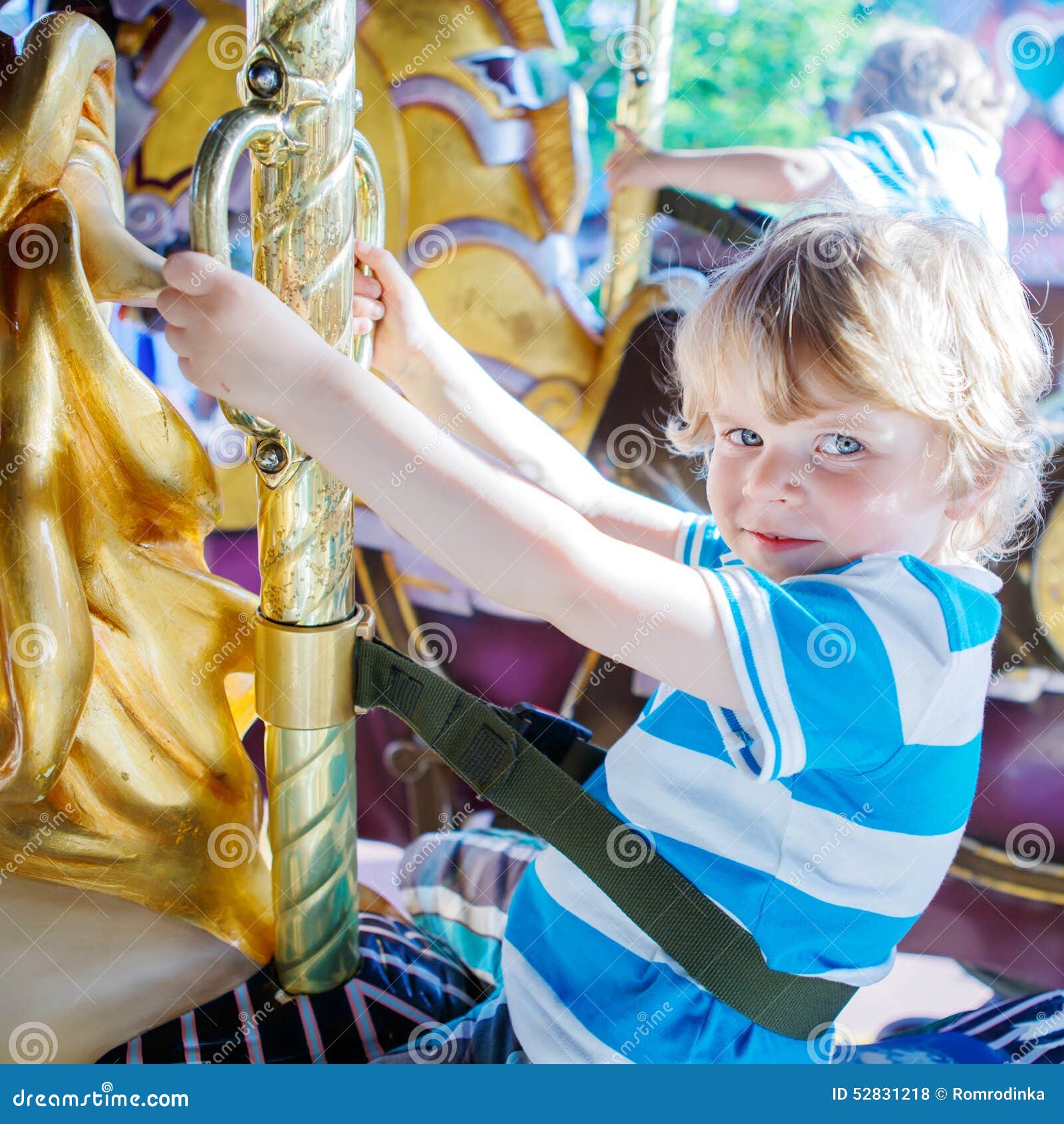 Little Cute Child during Carousel Ride, Enjoying and Having Fun Stock ...