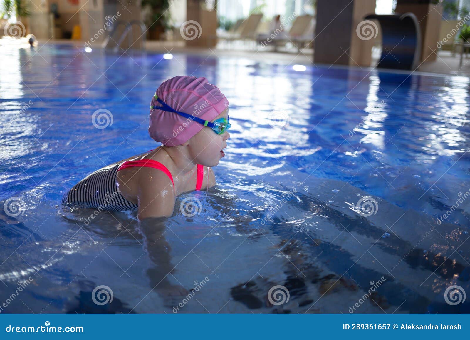 Little Cute Girl Performs Exercises at the Training in the Pool Stock ...