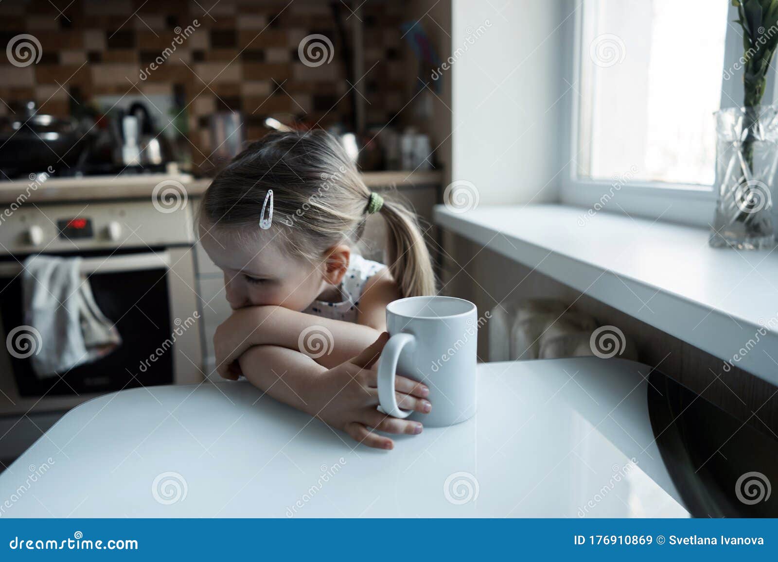 Little Cute Girl Sitting at the Table in the Kitchen Stock Image ...
