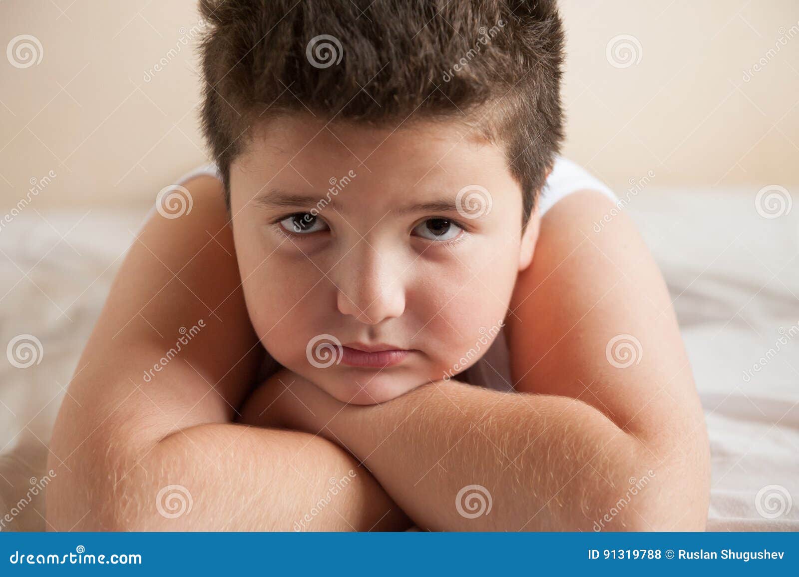 Little Fat Boy is Lying on the Bad Watching in To the Camera Stock ...