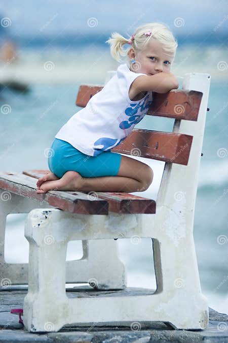Little girl on a bench stock photo. Image of clear, bench - 7110706