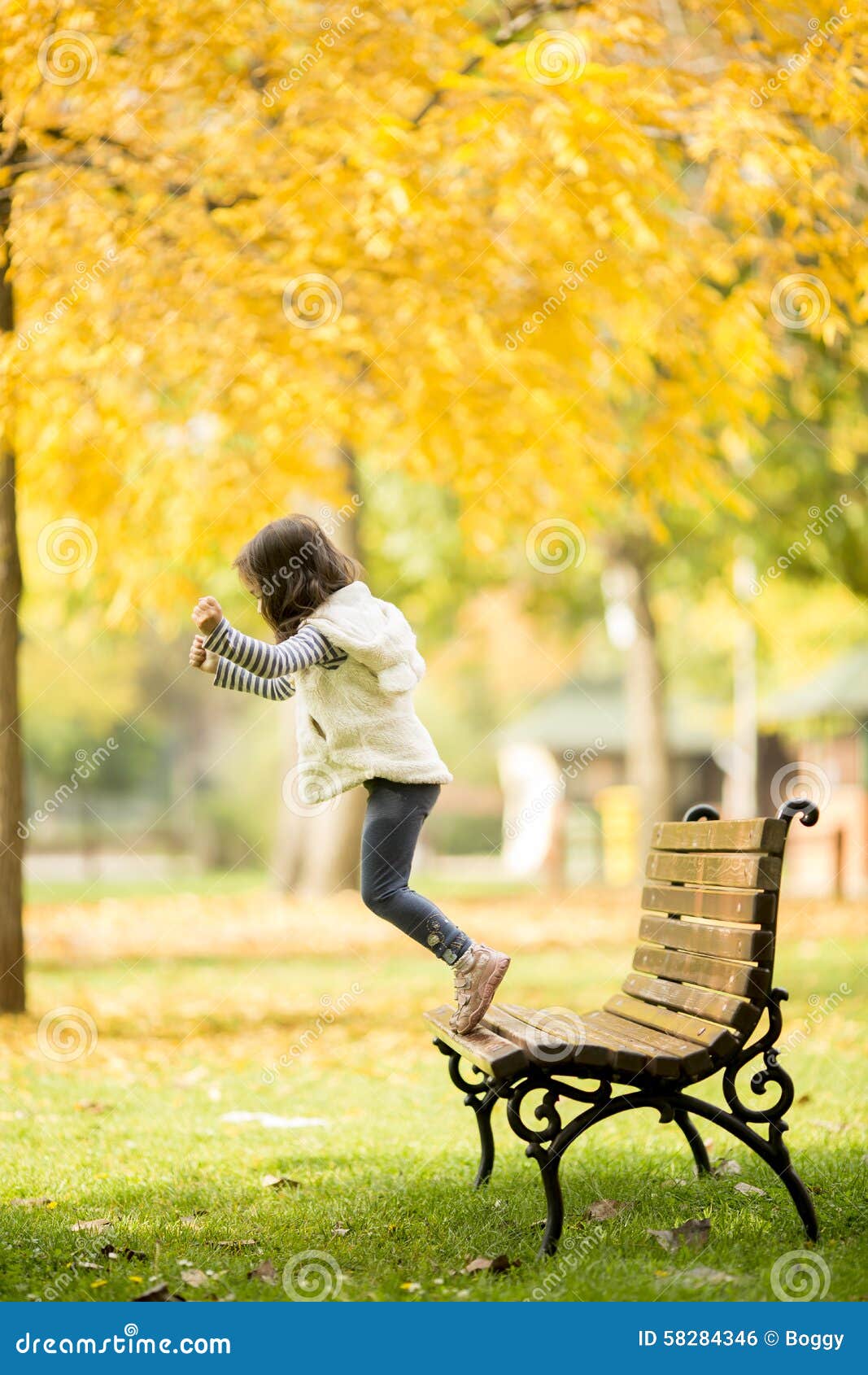 Little girl at the bench stock photo. Image of outside - 58284346