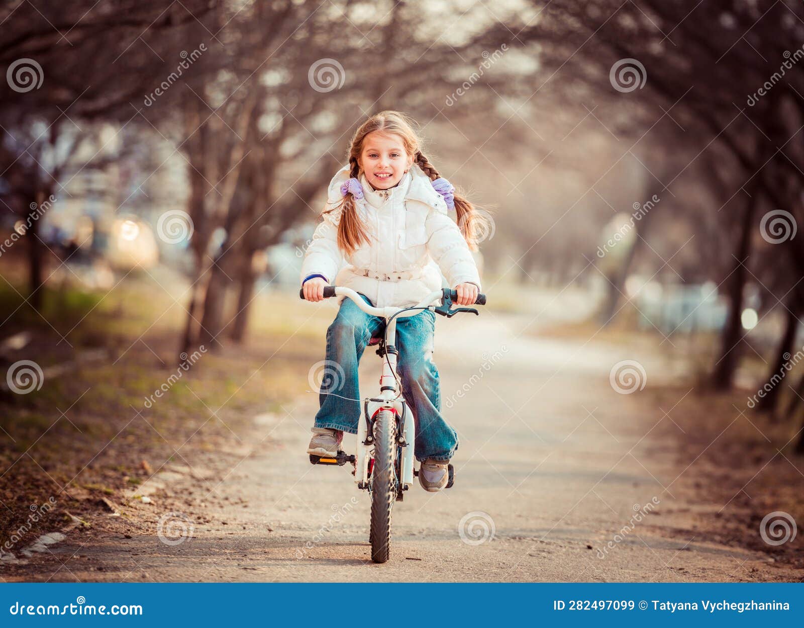 Little girl on a bicycle stock image. Image of park - 282497099