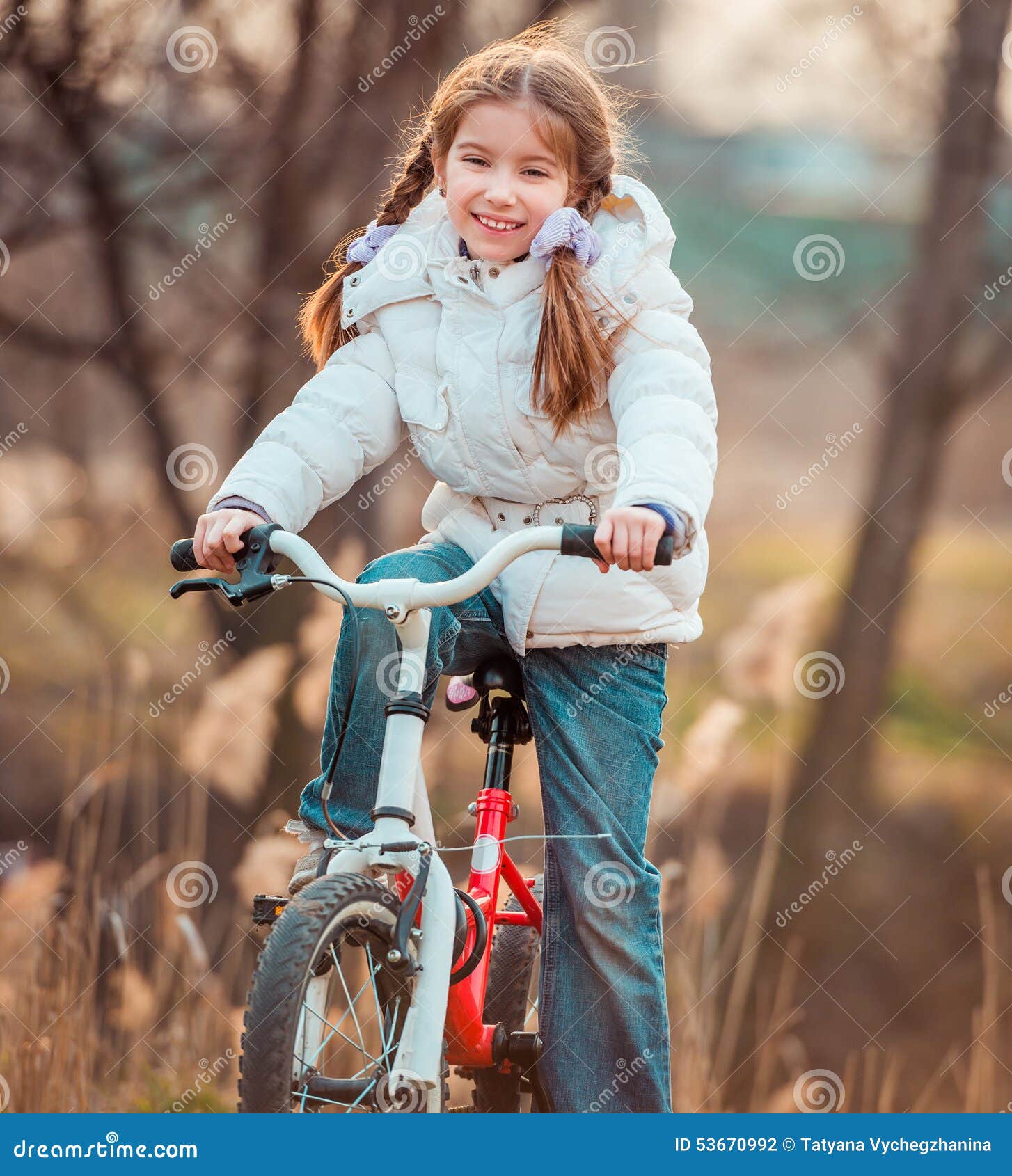 Little girl on a bicycle stock photo. Image of happiness - 53670992