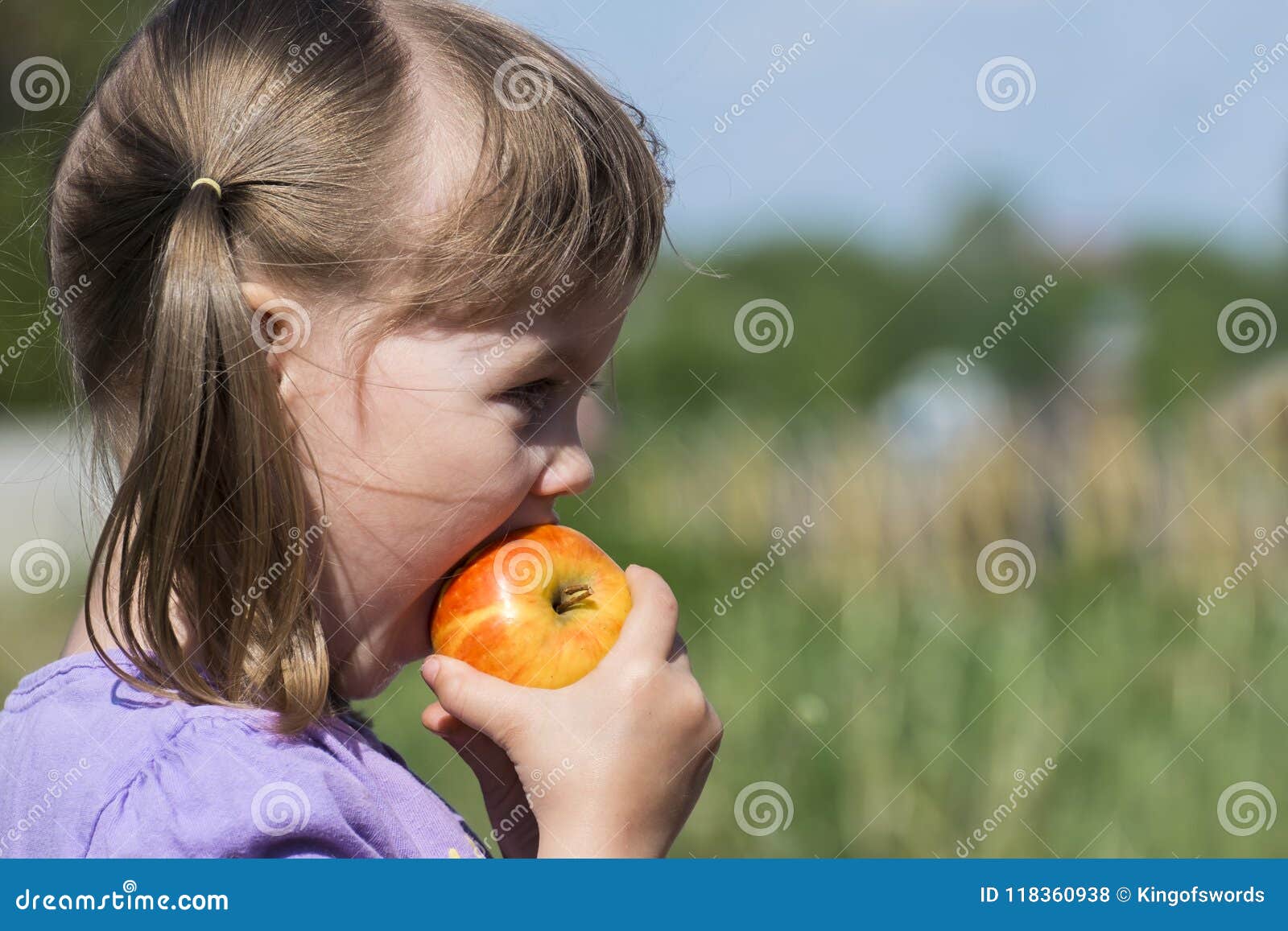 Little Girl Bites a Ruddy Apple Stock Photo - Image of young, spring ...