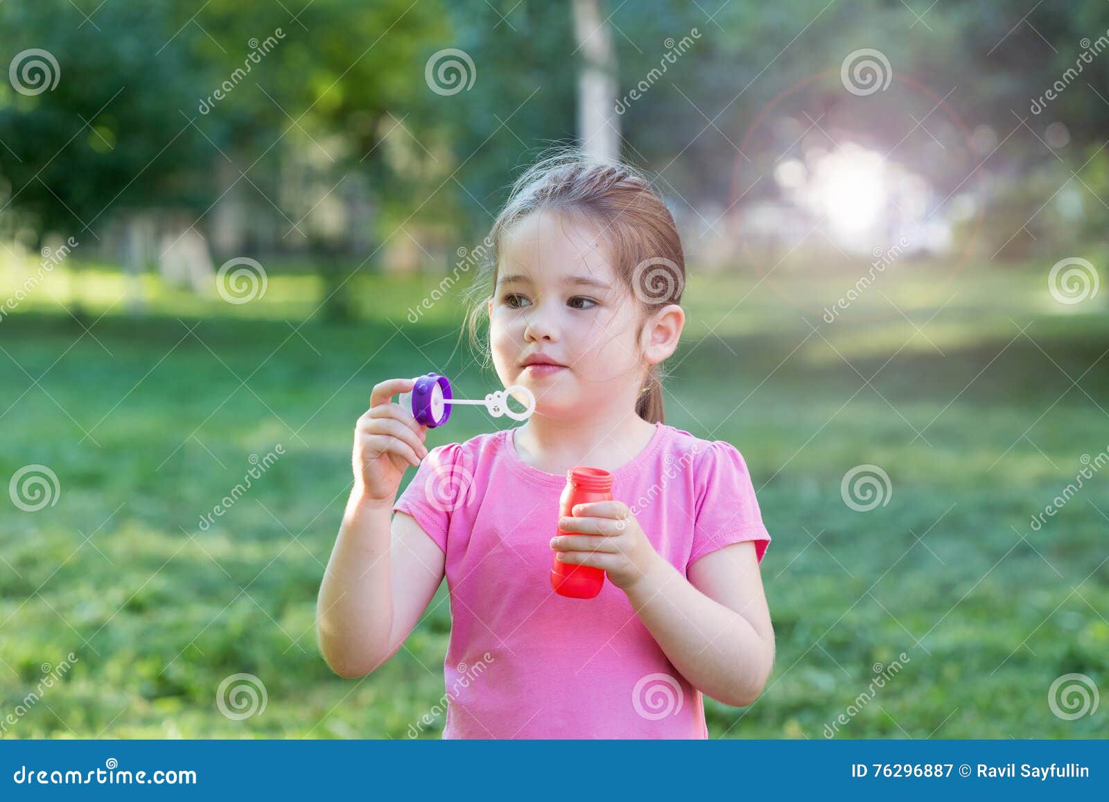 A Little Girl Blowing Soap Bubbles in a Park Stock Image - Image of ...
