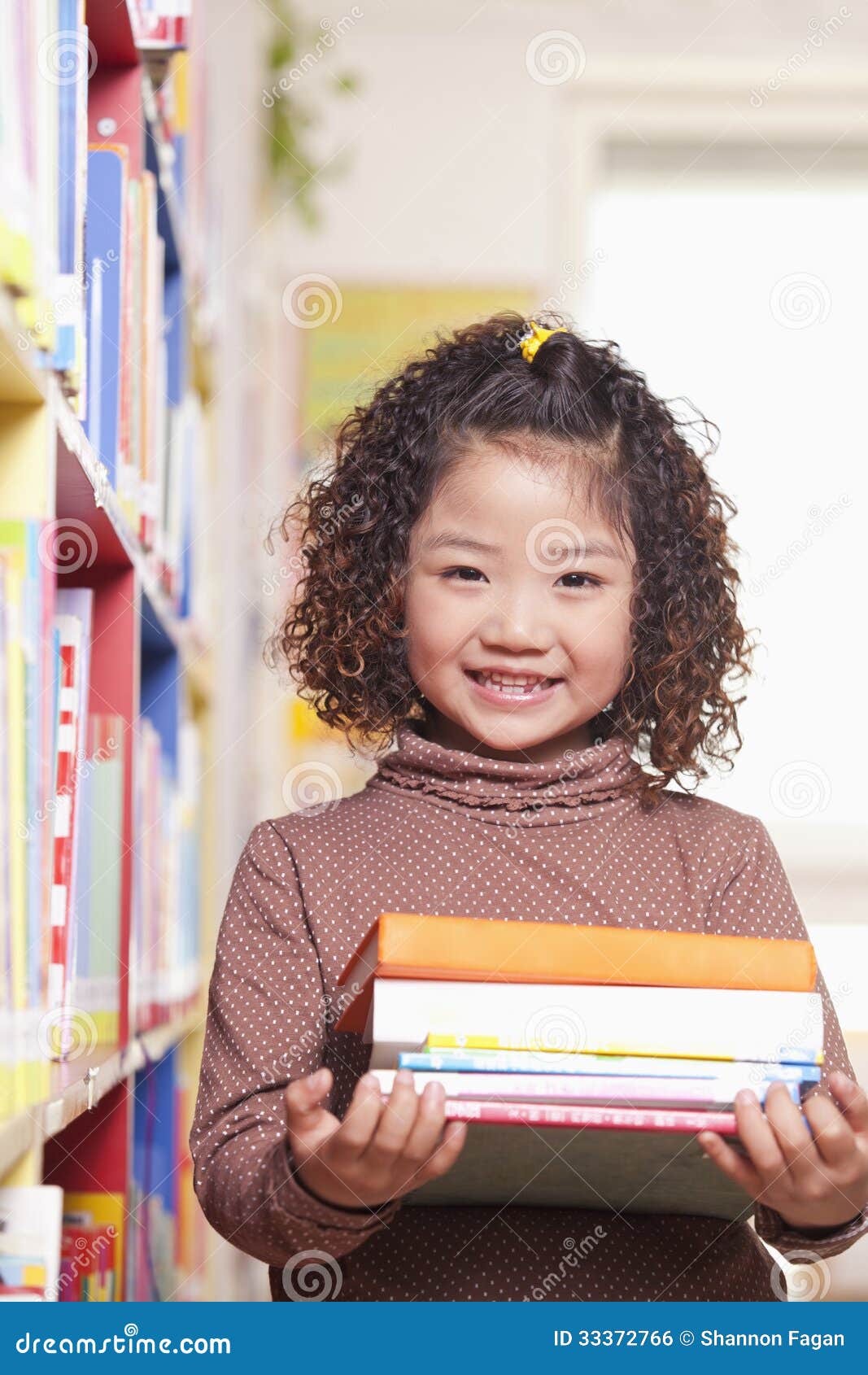 Little Girl Carrying Books stock photo. Image of front - 33372766
